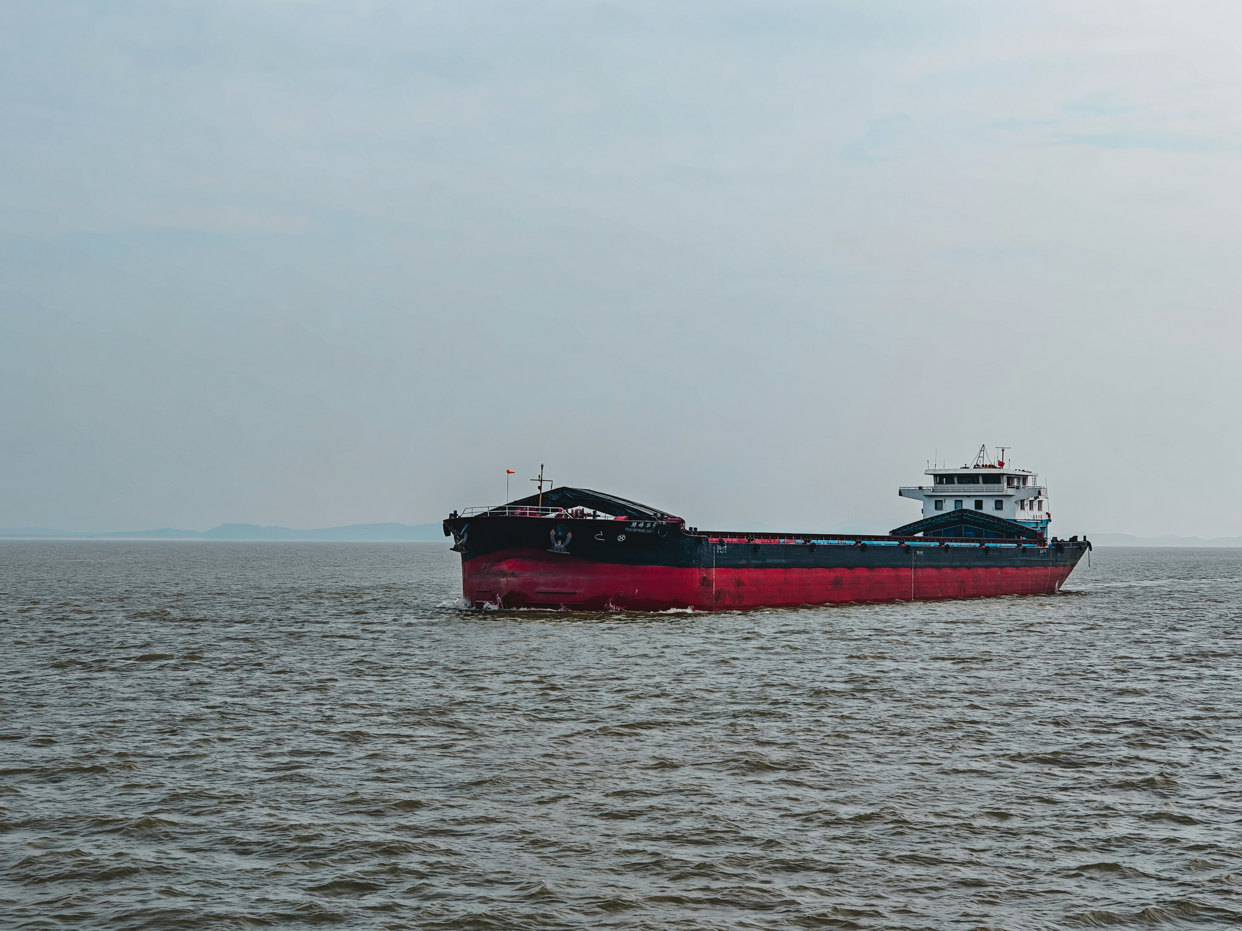 Red Freighter on a Calm Sea