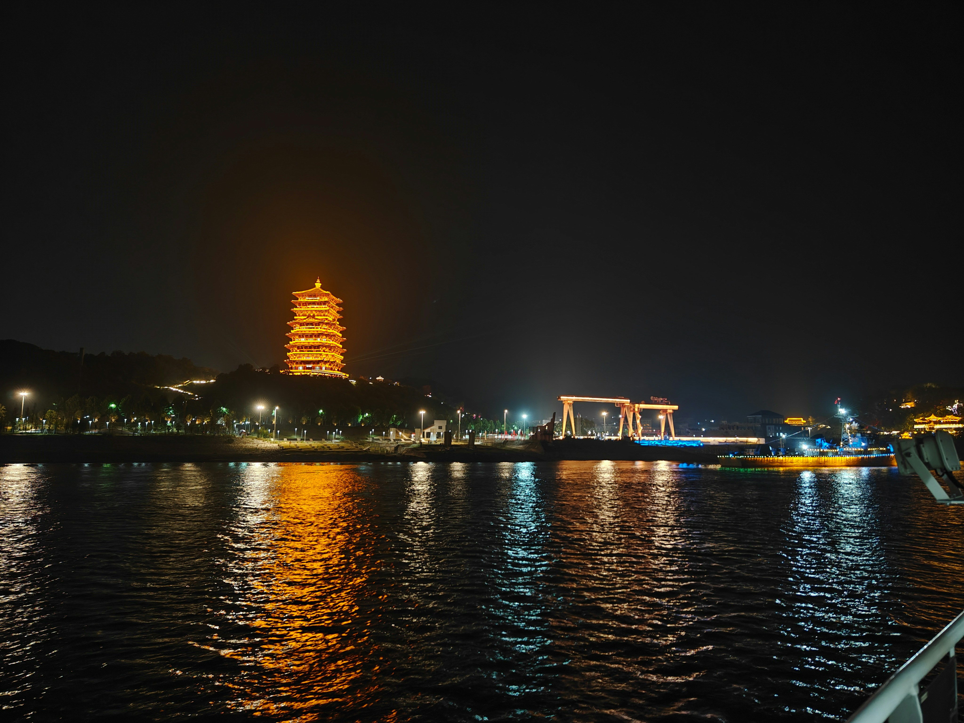 Luminous Pagoda by the River: Nightscape with Reflections