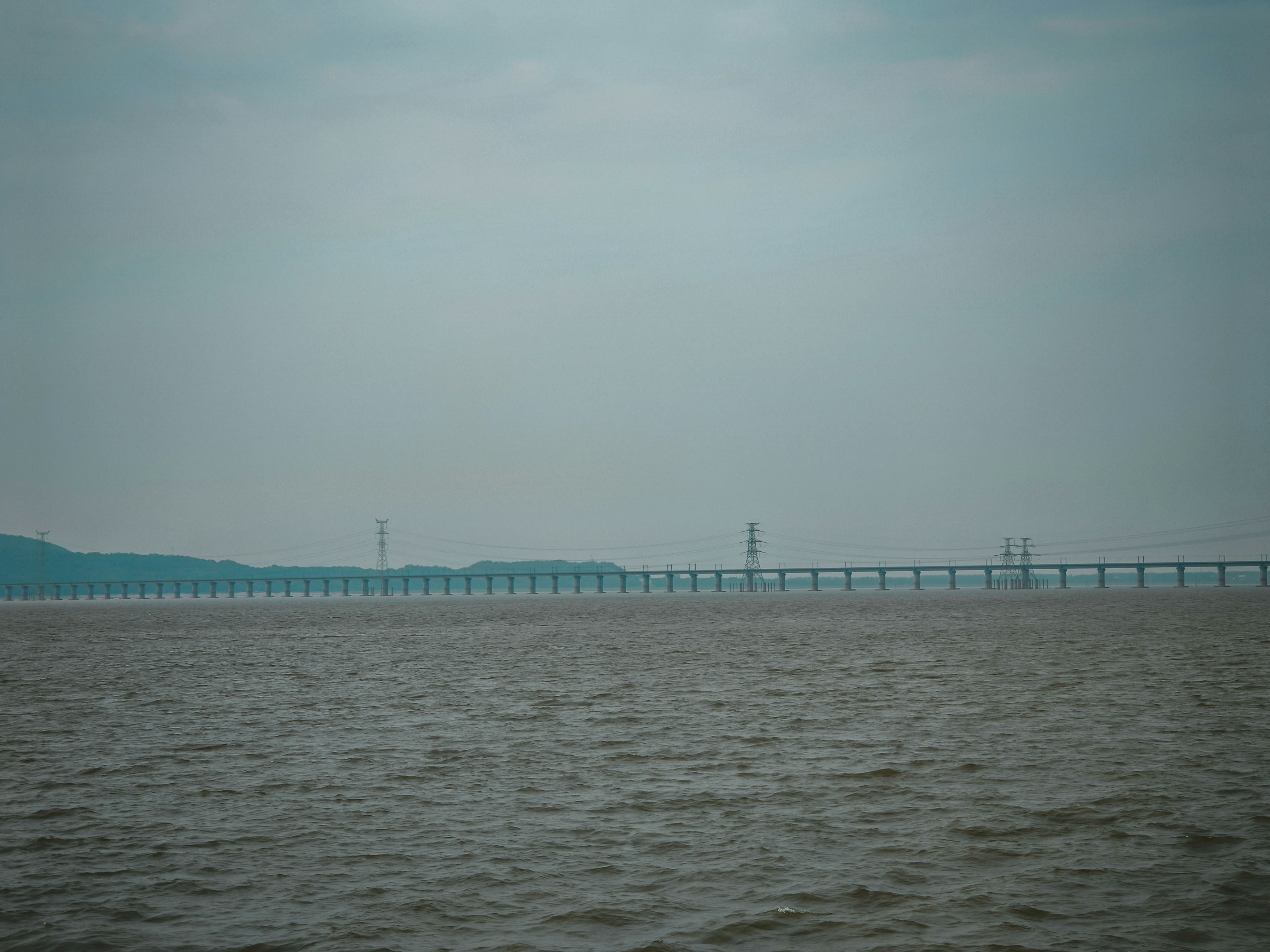 Bridge Silhouette over a Calm Harbor at Dusk