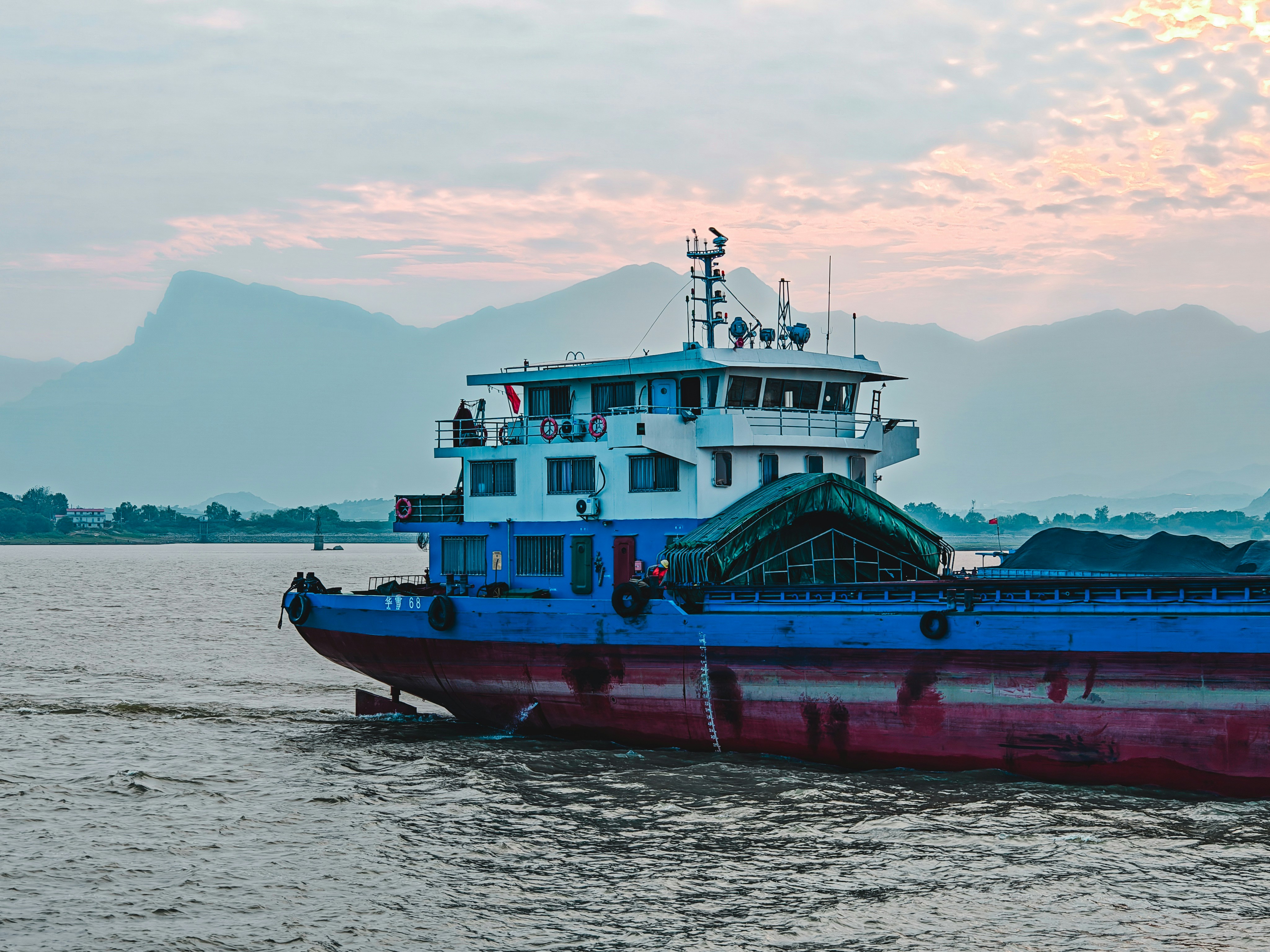 Blue Coastliner at Dusk: A Steady Bow on Quiet Waters