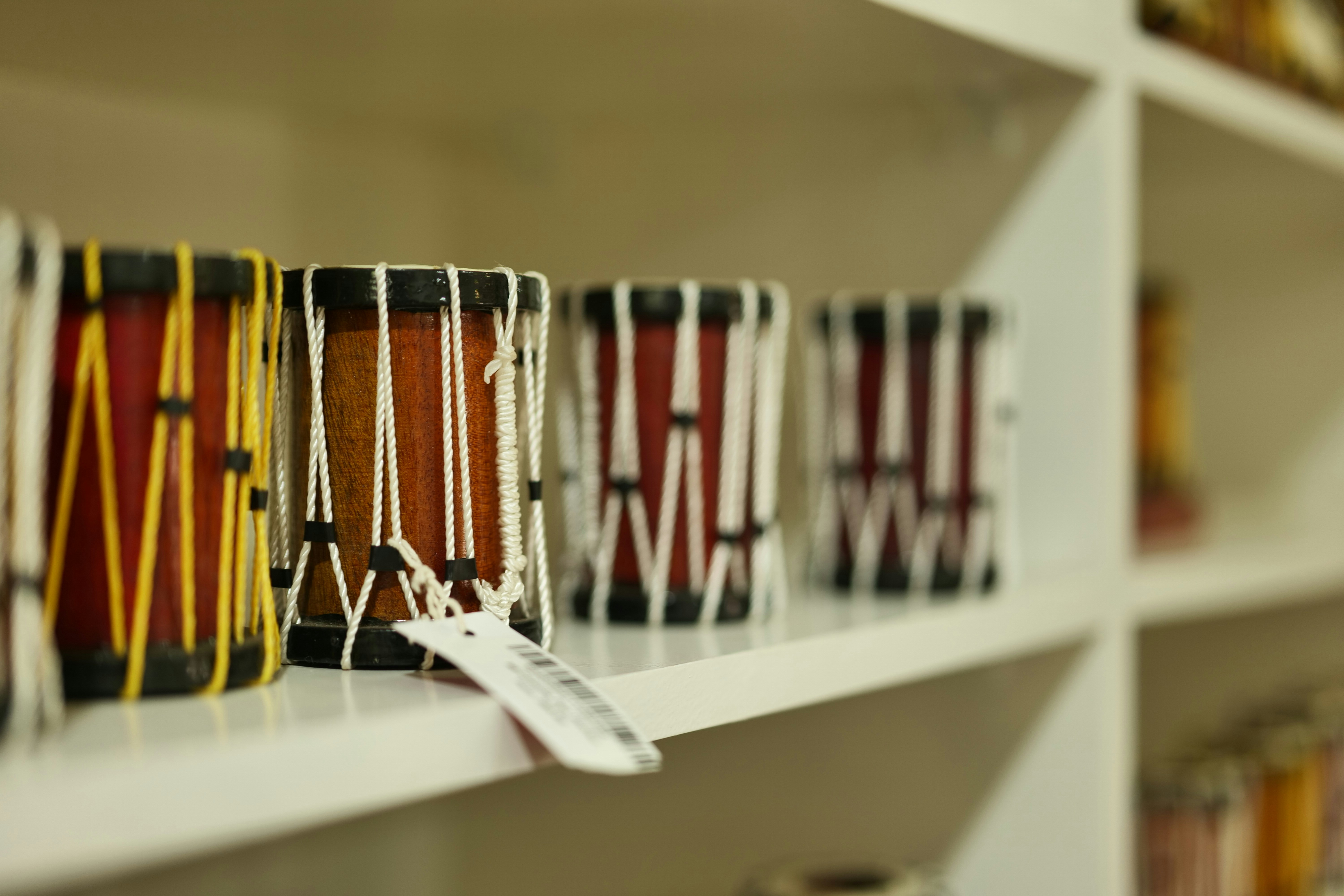 Drums on a Shelf: A Row of Small Handcrafted Percussion Instruments