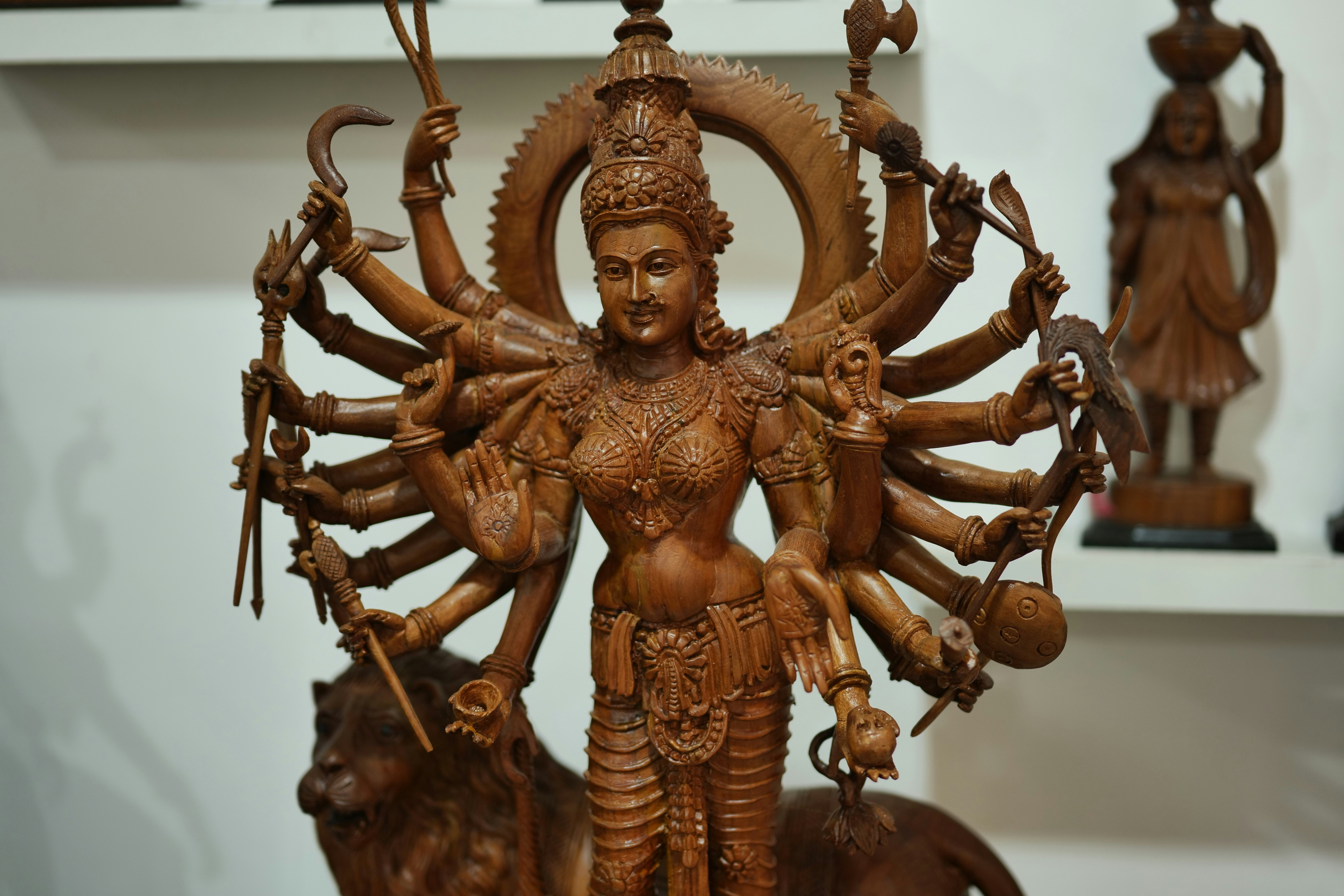 Nine-Armed Serenity: A Polished Wooden Avalokiteshvara Statue
