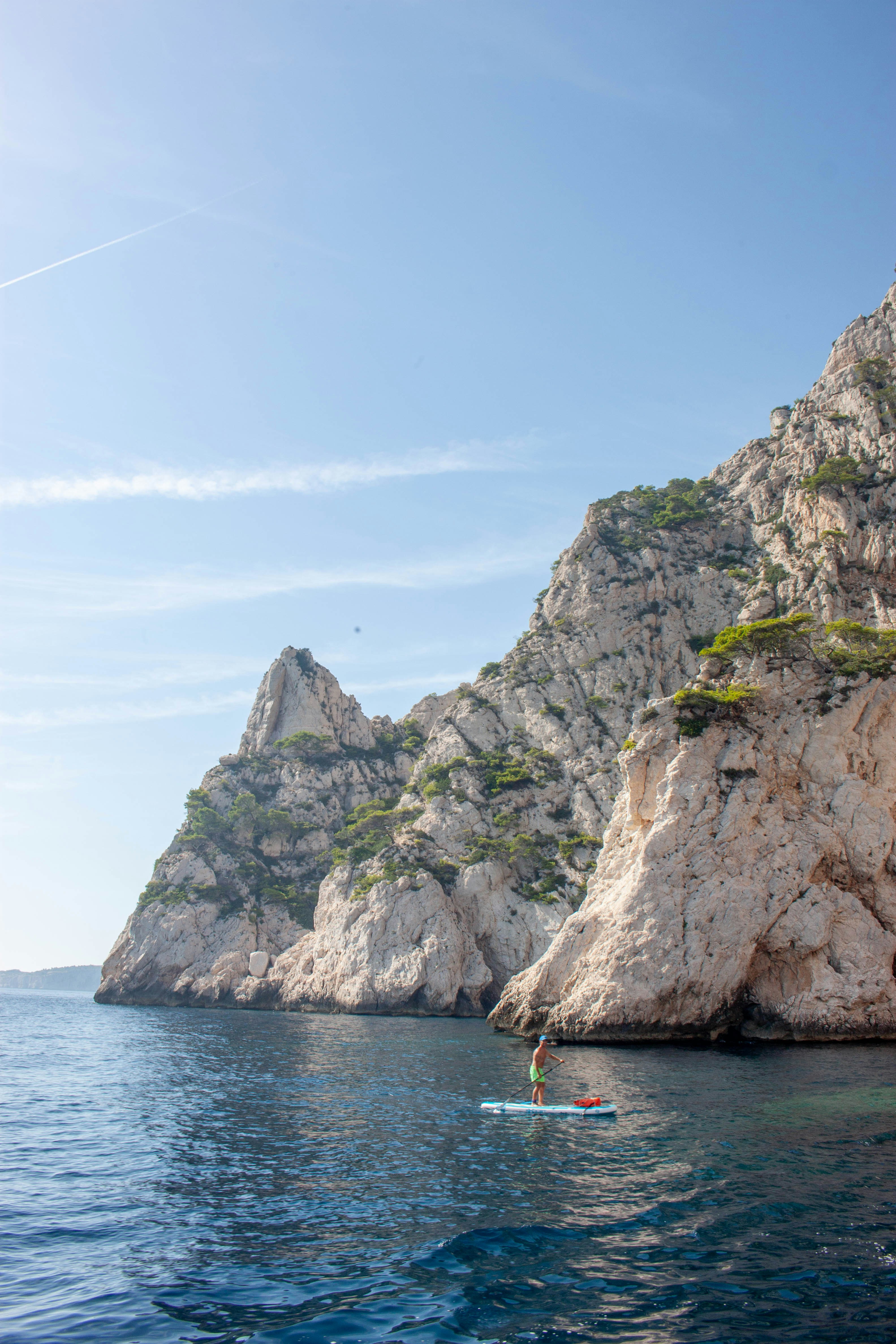Stand‑up Paddleboarder at the Edge of a Limestone Cliff