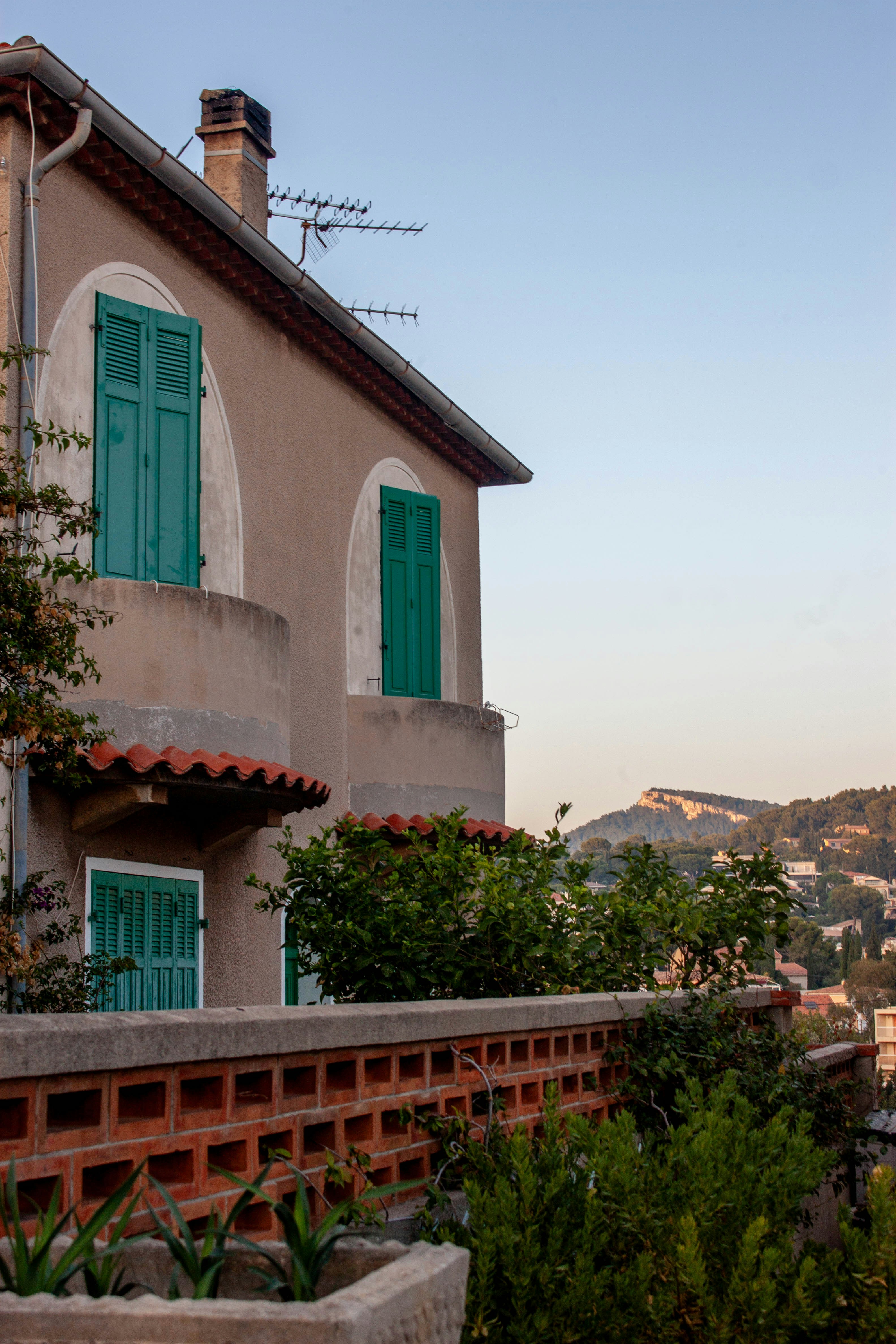 Teal Shutters and Terrace Lines on a Mediterranean Home