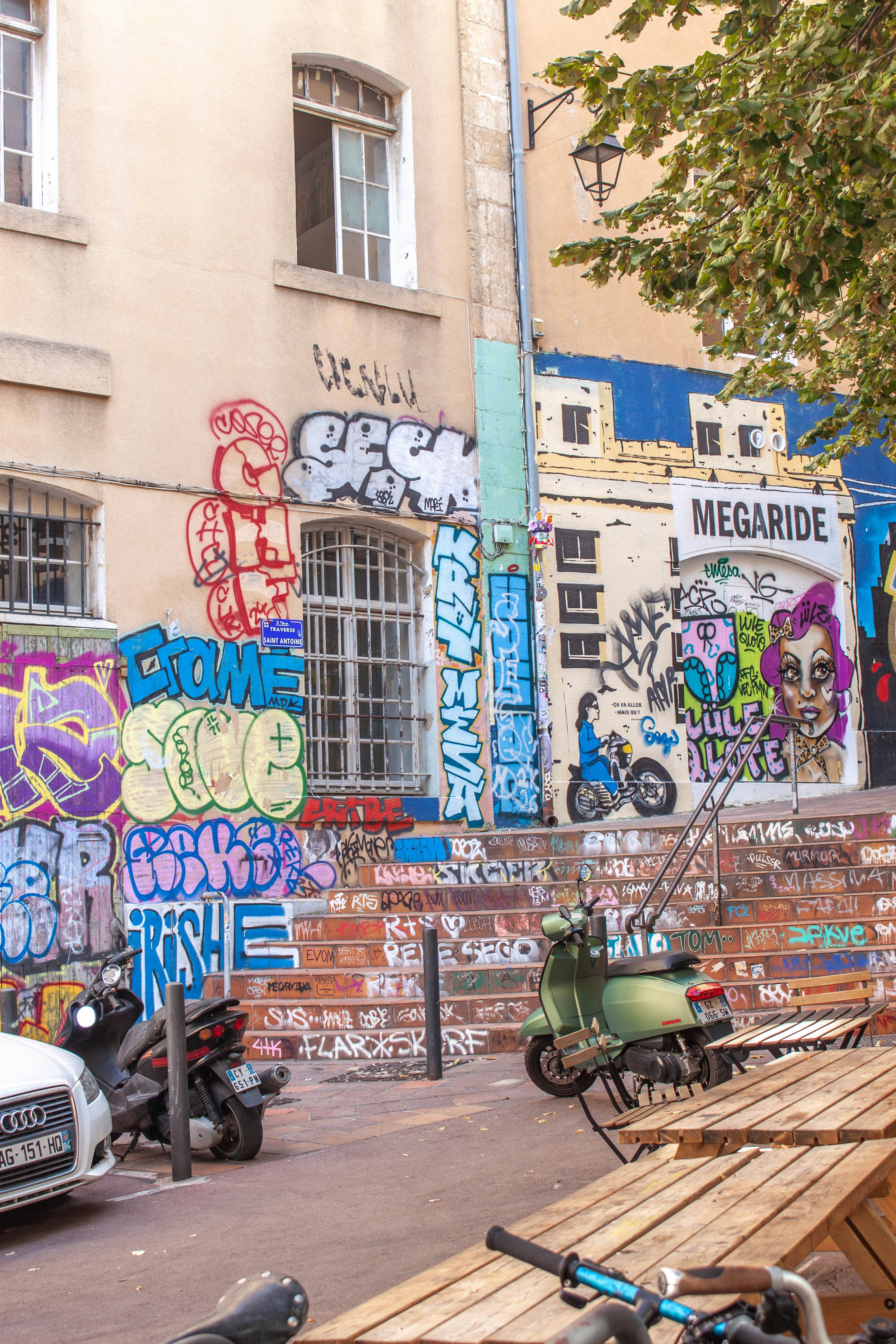Urban Canvas: Graffiti Portrait and Alleyway in Colorful Ruin