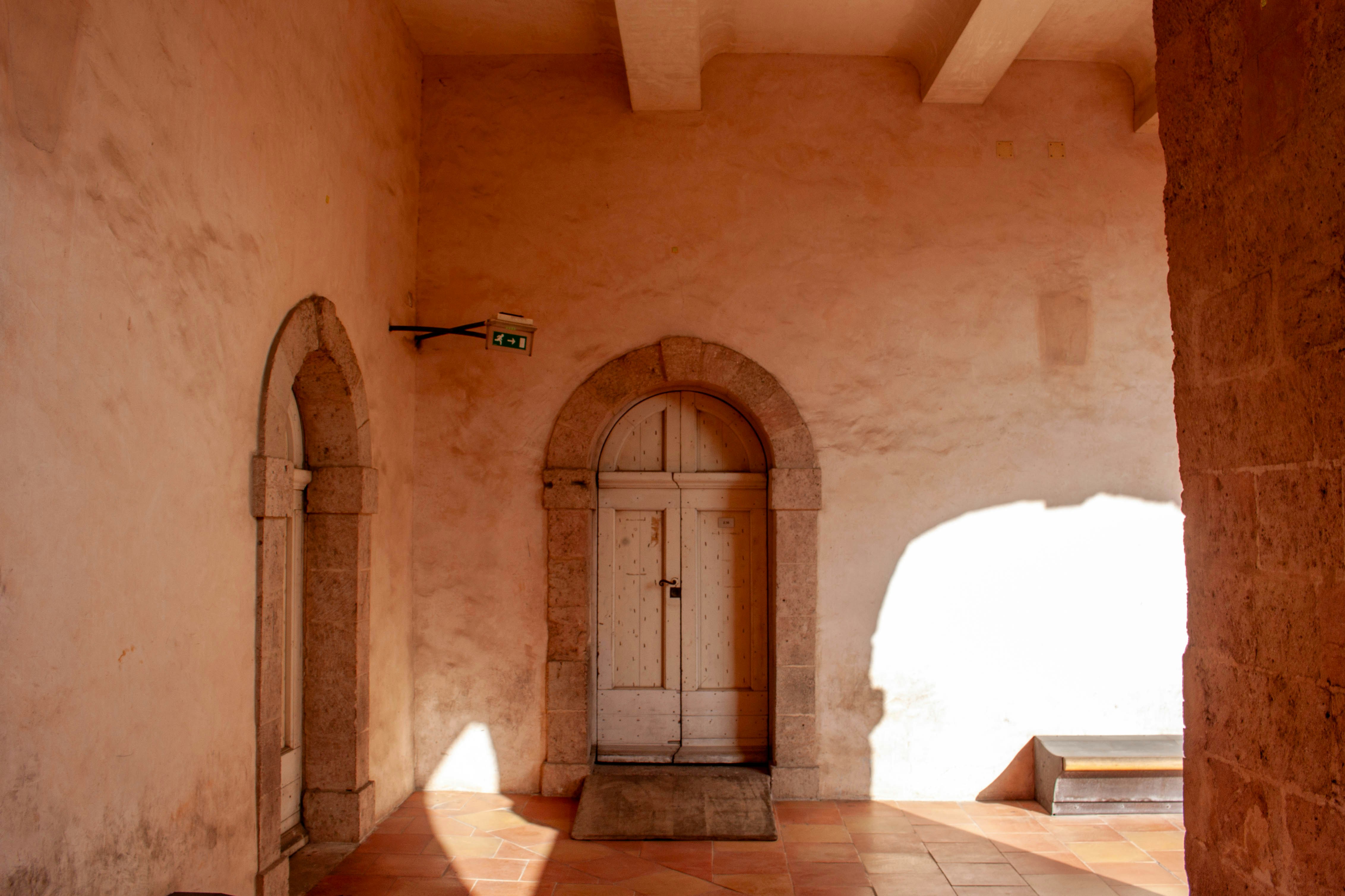 Sunlit Archway and Center Doorway in Warm Terrace