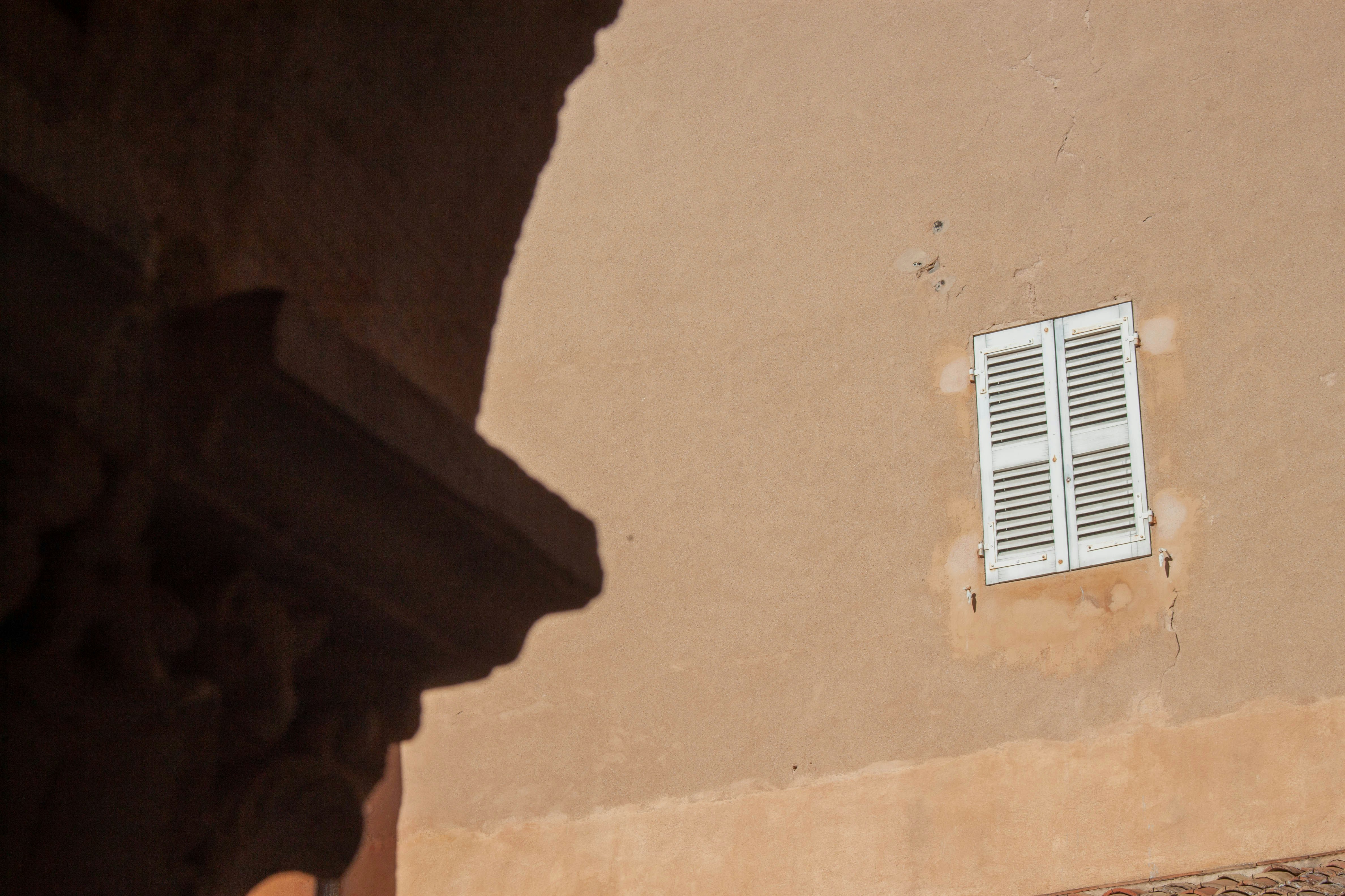 Windowed Calm on a Sunlit Facade