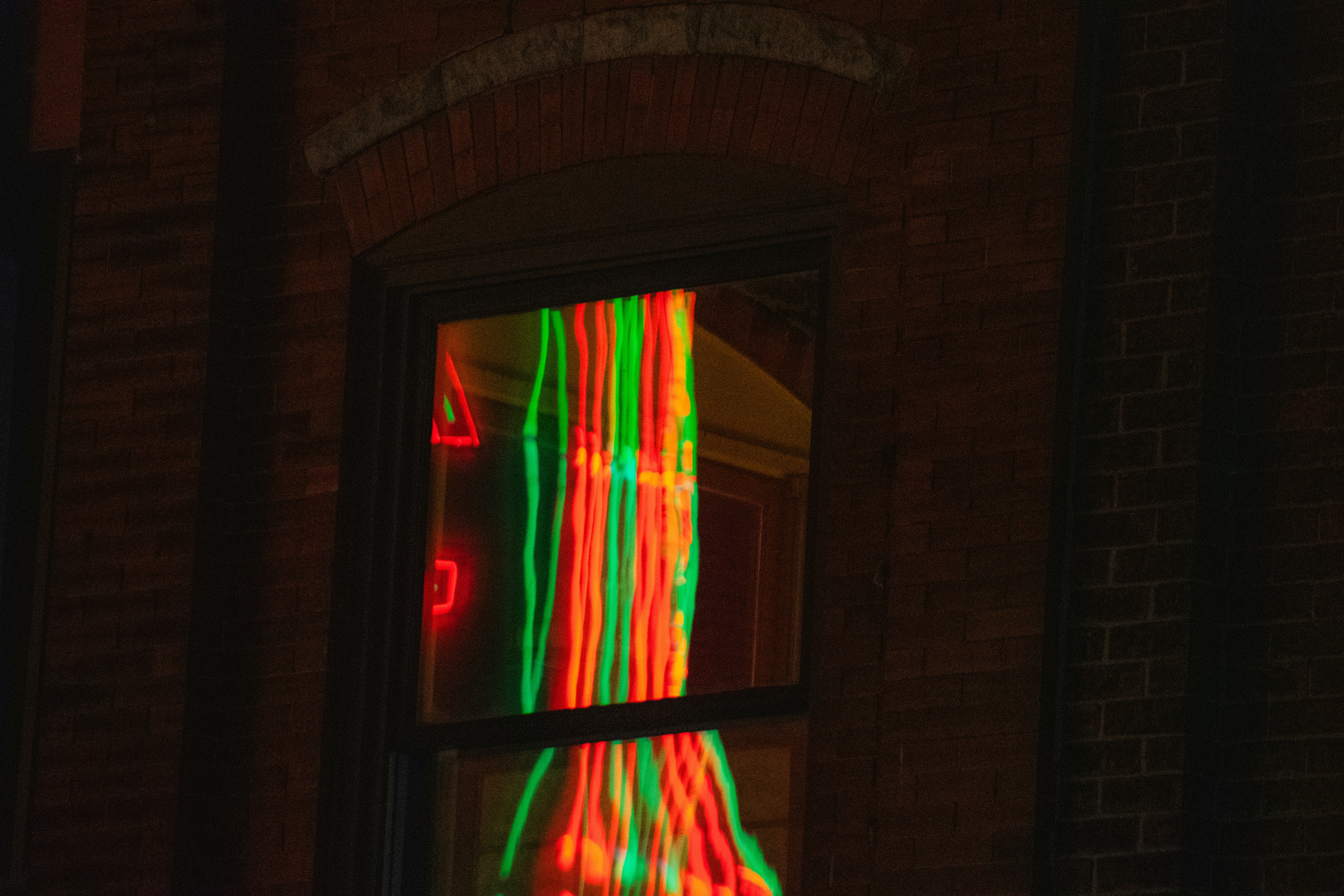 Neon Windowlight in a Midnight Brick Facade