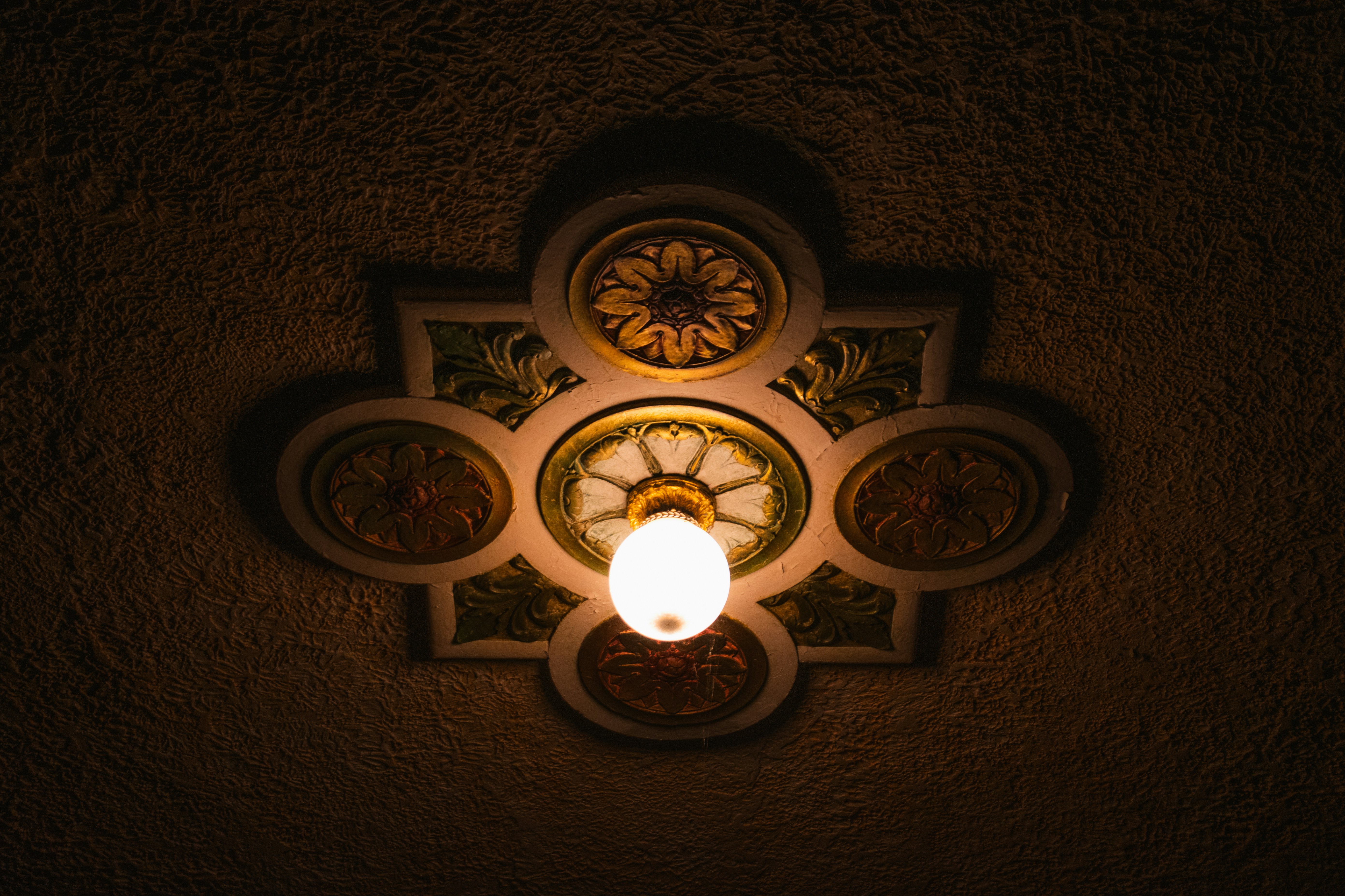 Ornate Ceiling Bloom Framed by Warm Glow