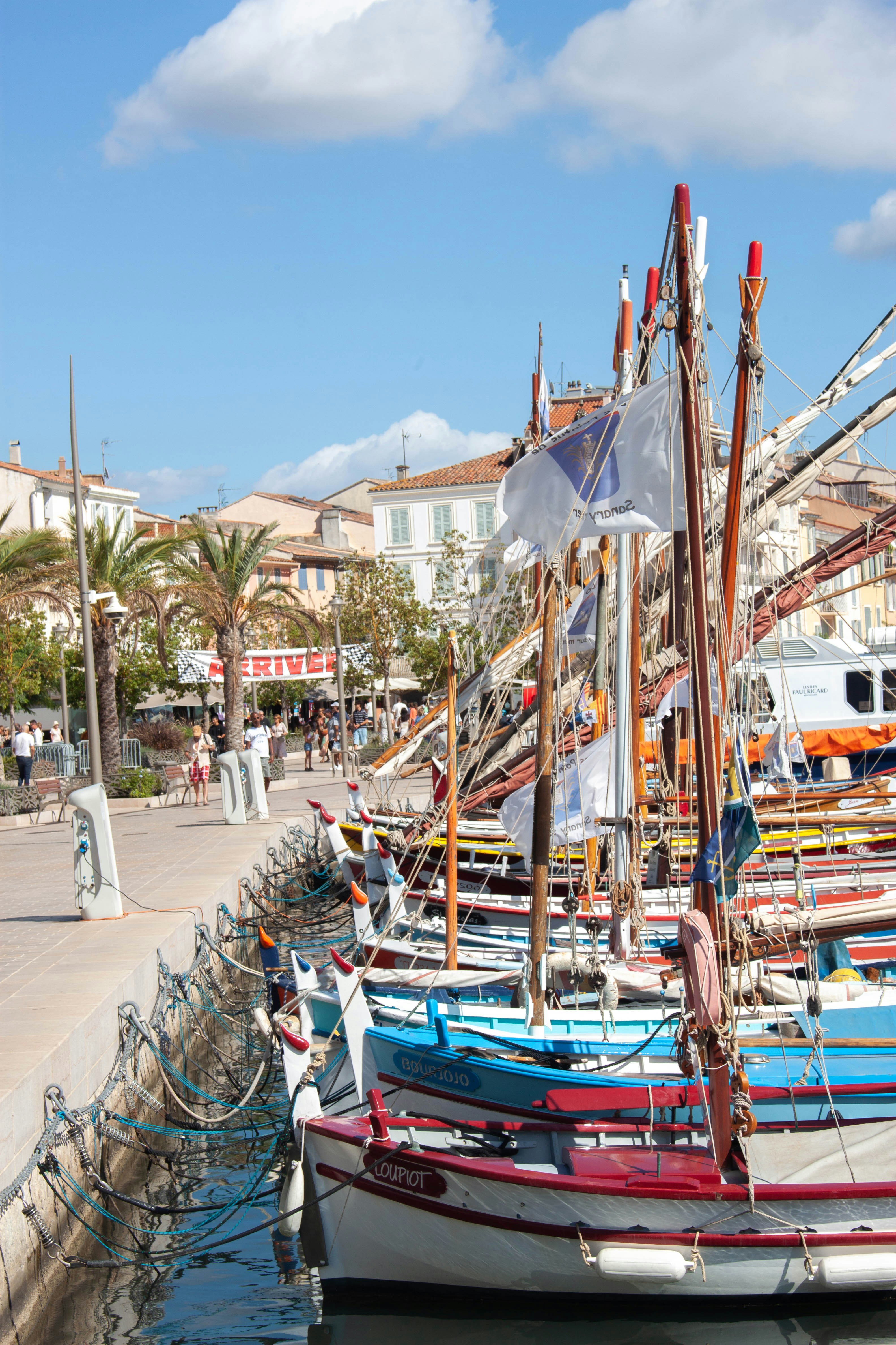 Sunlit Marina Row: Boats and Boulevards in Warm Seascape