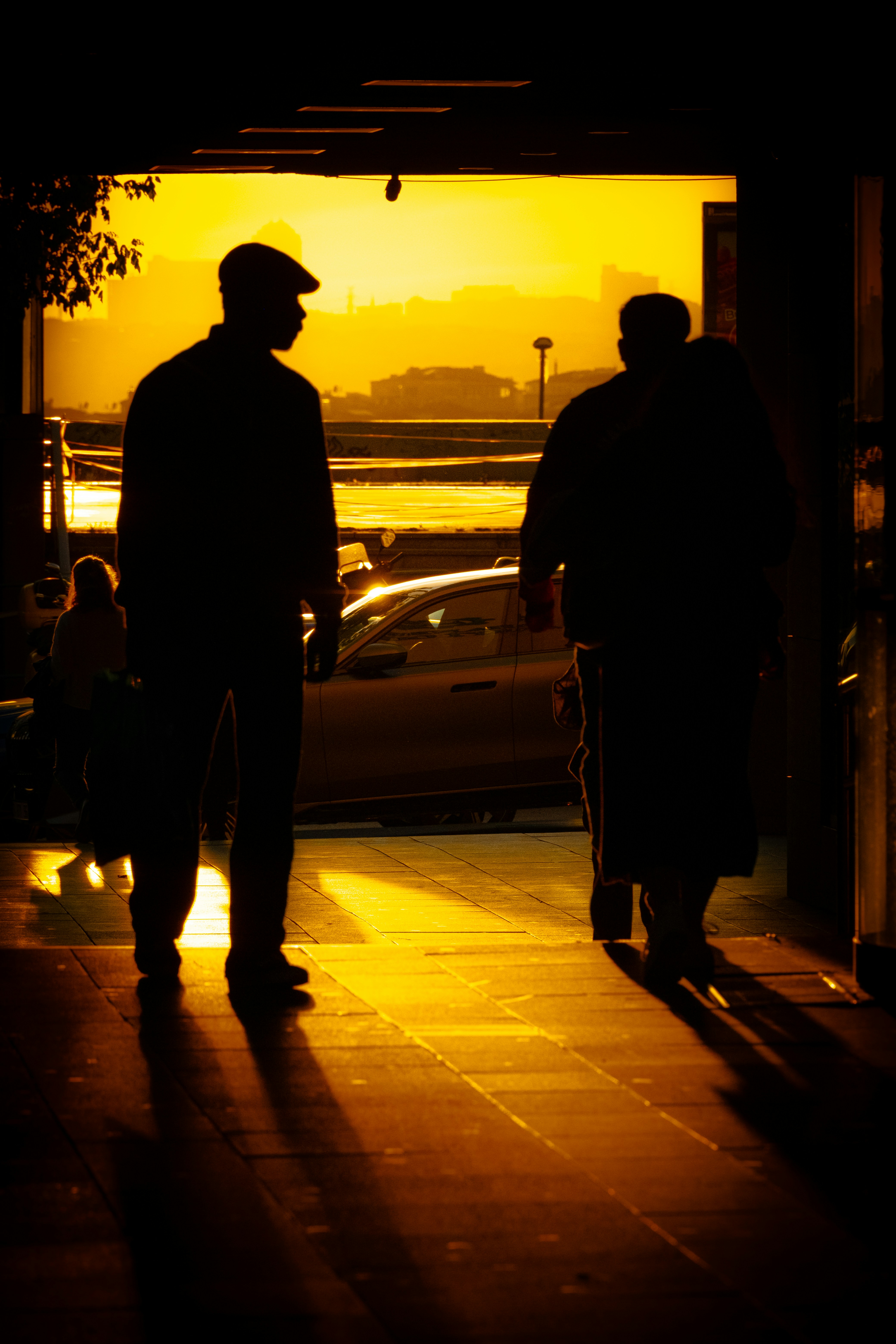 Golden Corridor: Silhouetted Striders in a Backlit Hallway