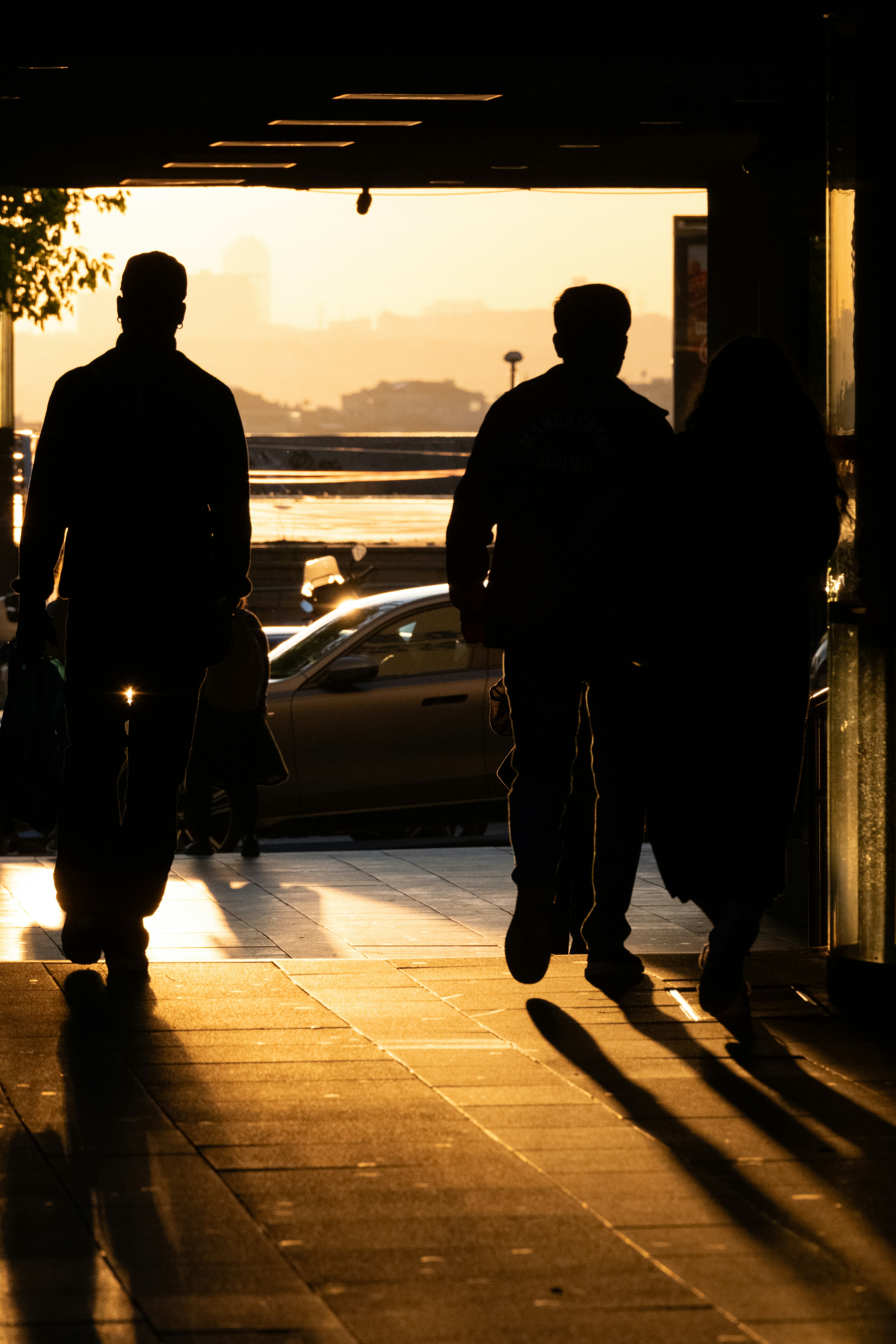 Silhouettes in Golden Hour: Trio Entering the Light