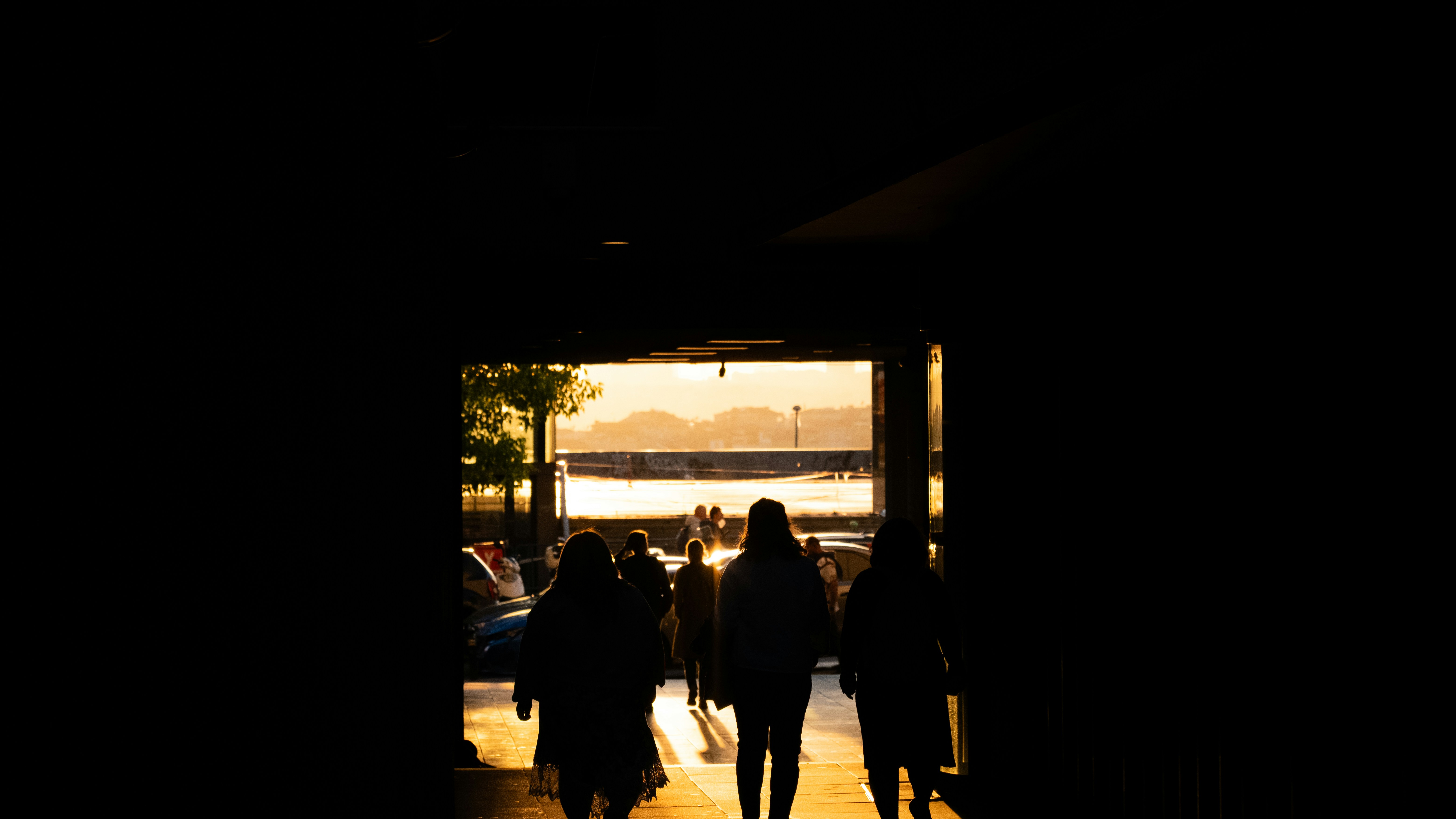 Silhouette Landing: People Entering a Lighted Dock at Sunset