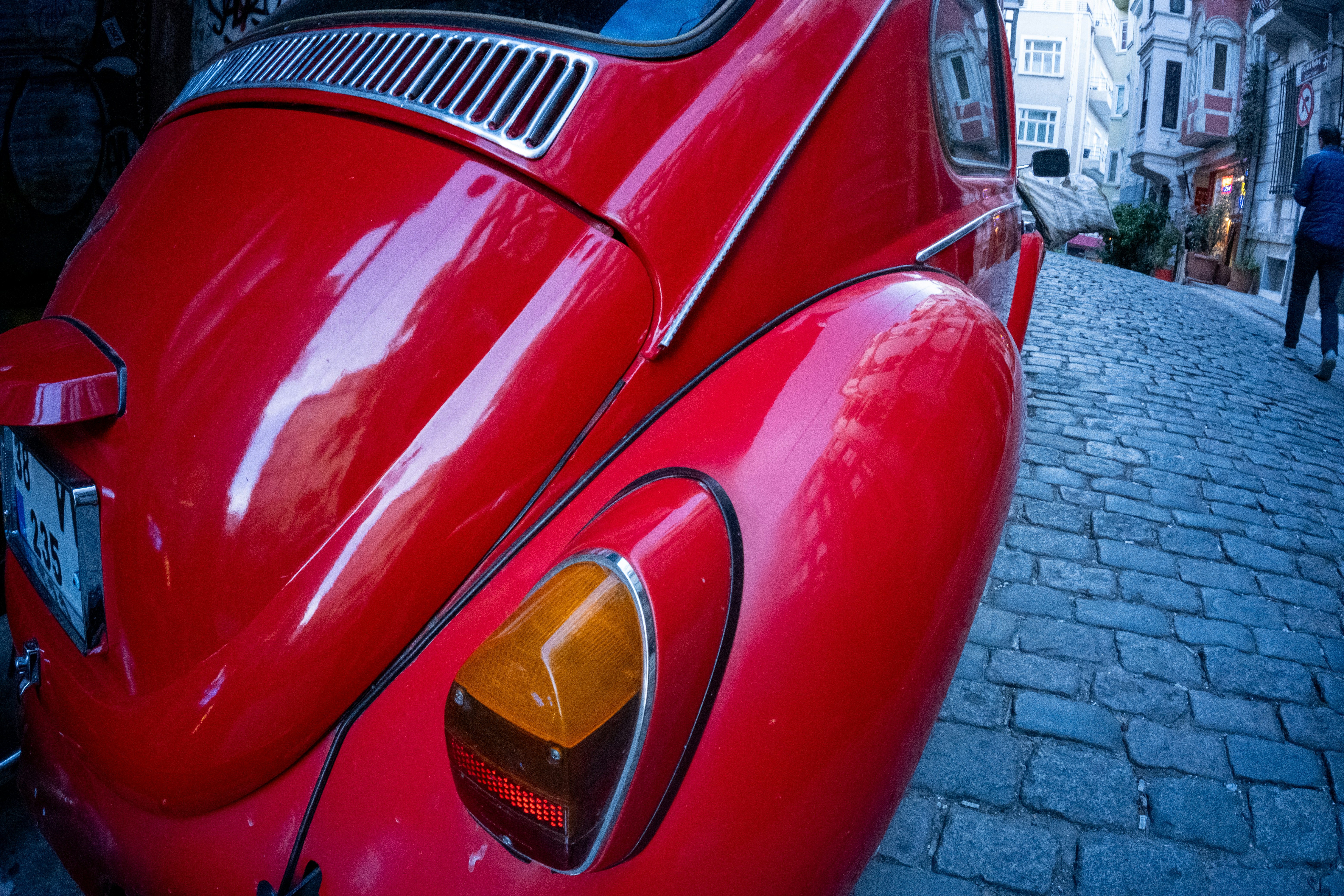 Red Beetle, Stony Lane: A Close-Cropped Moment on a Cobblestone Street