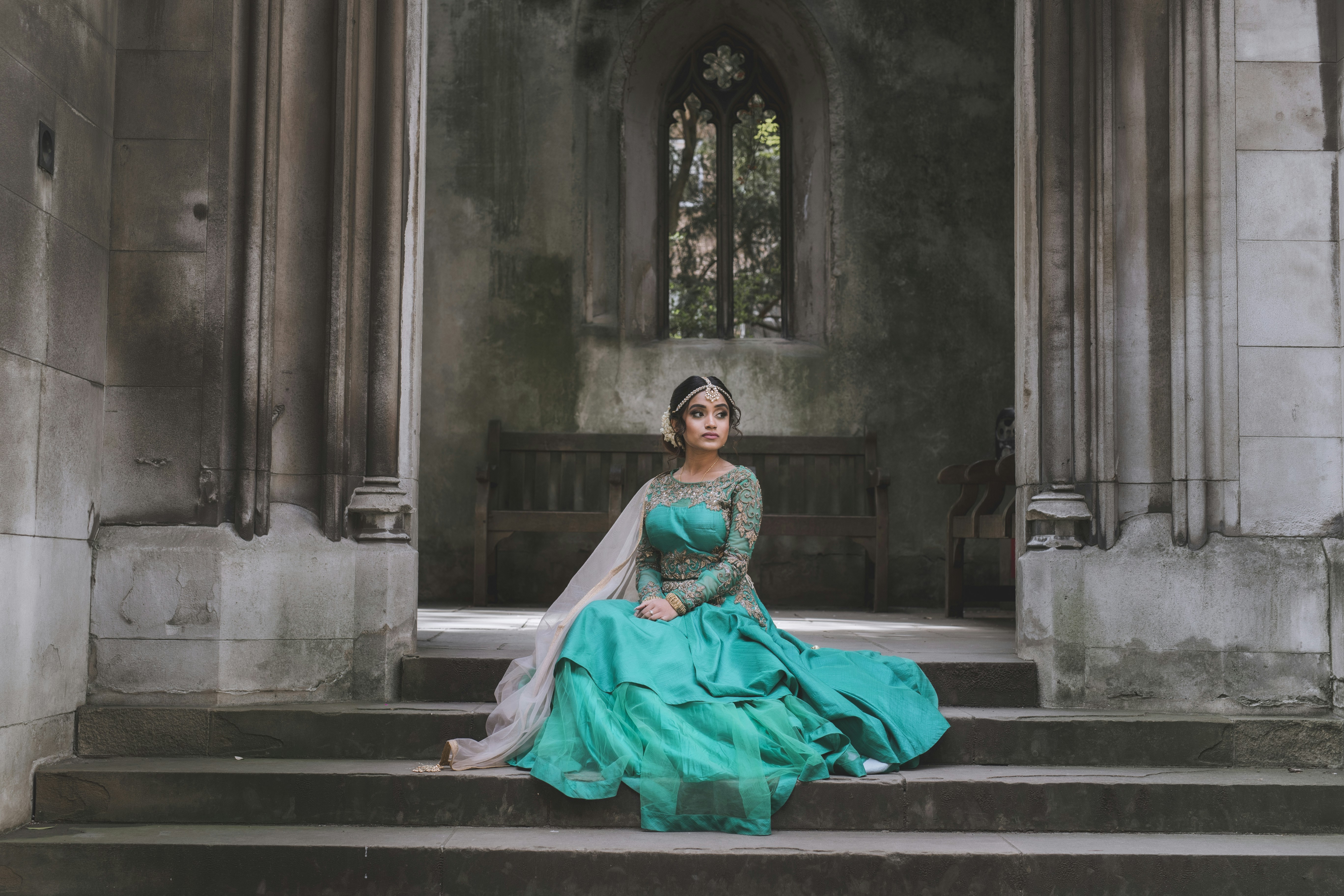 Emerald-gown moment on stone steps