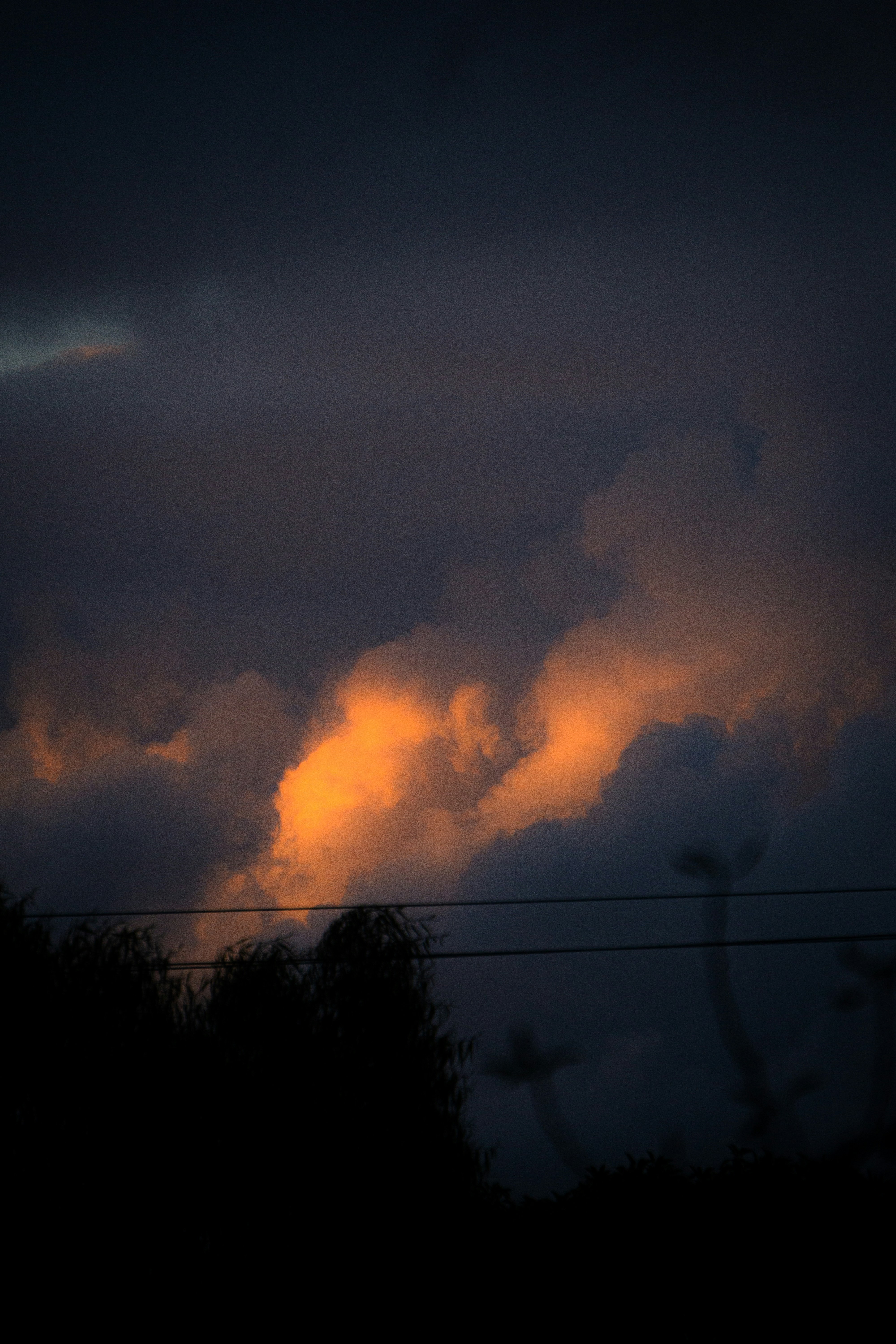Orange Cloud Burst Across a Dusk Ridge