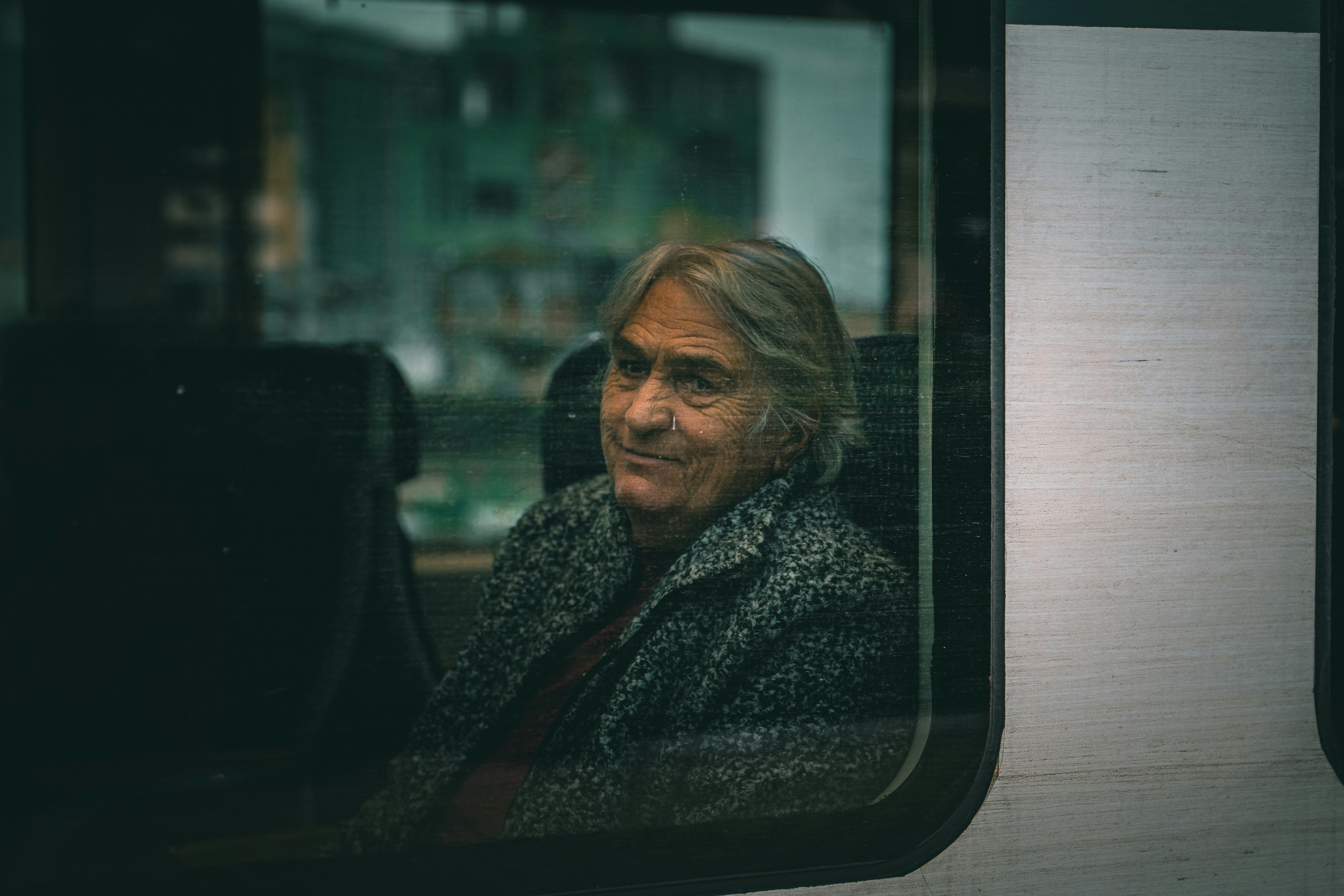 Windowsill Portrait: Calm Elder on a Train