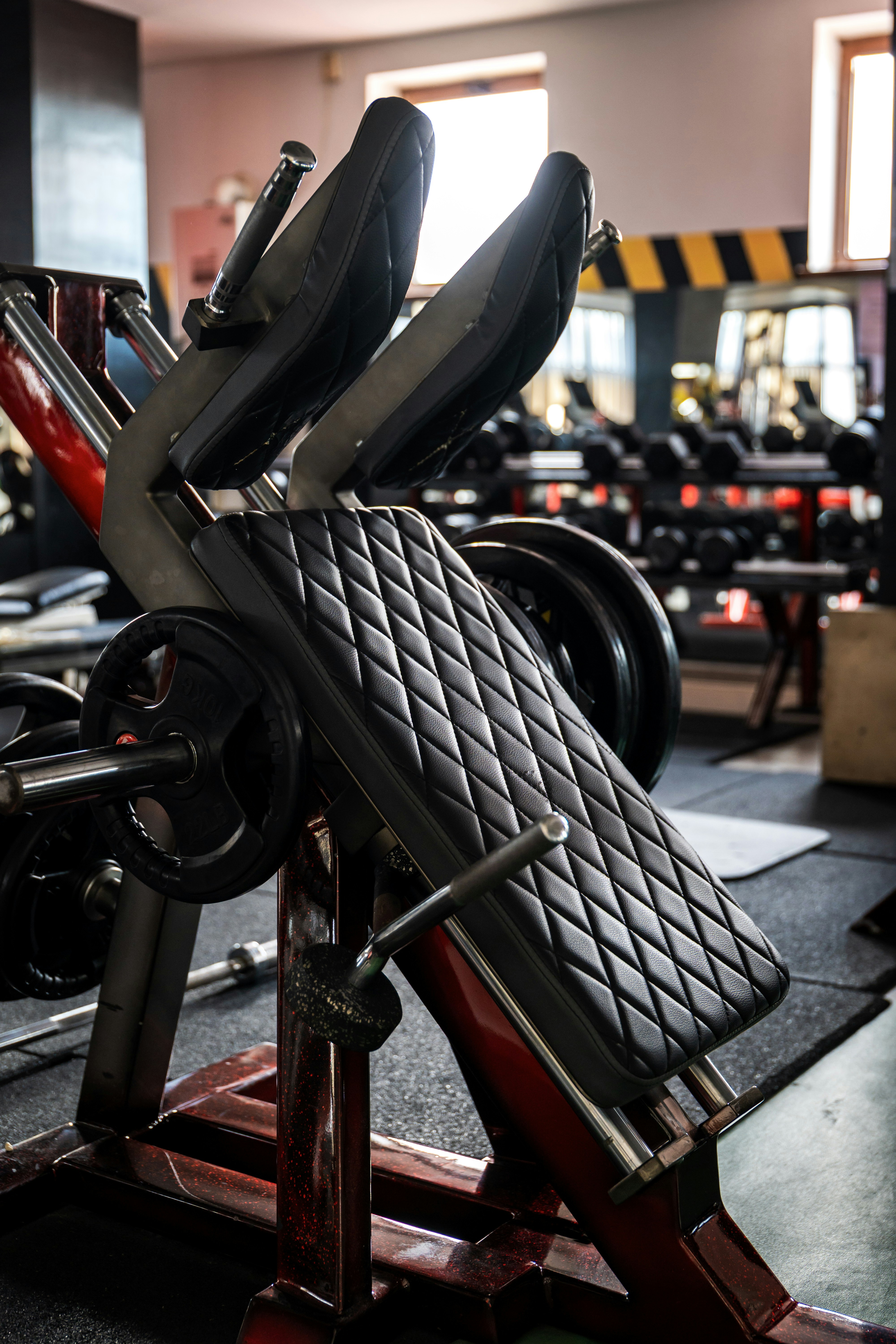 Quilted Bench Press: A Close-Up of a Fitness Machine in a Busy Gym