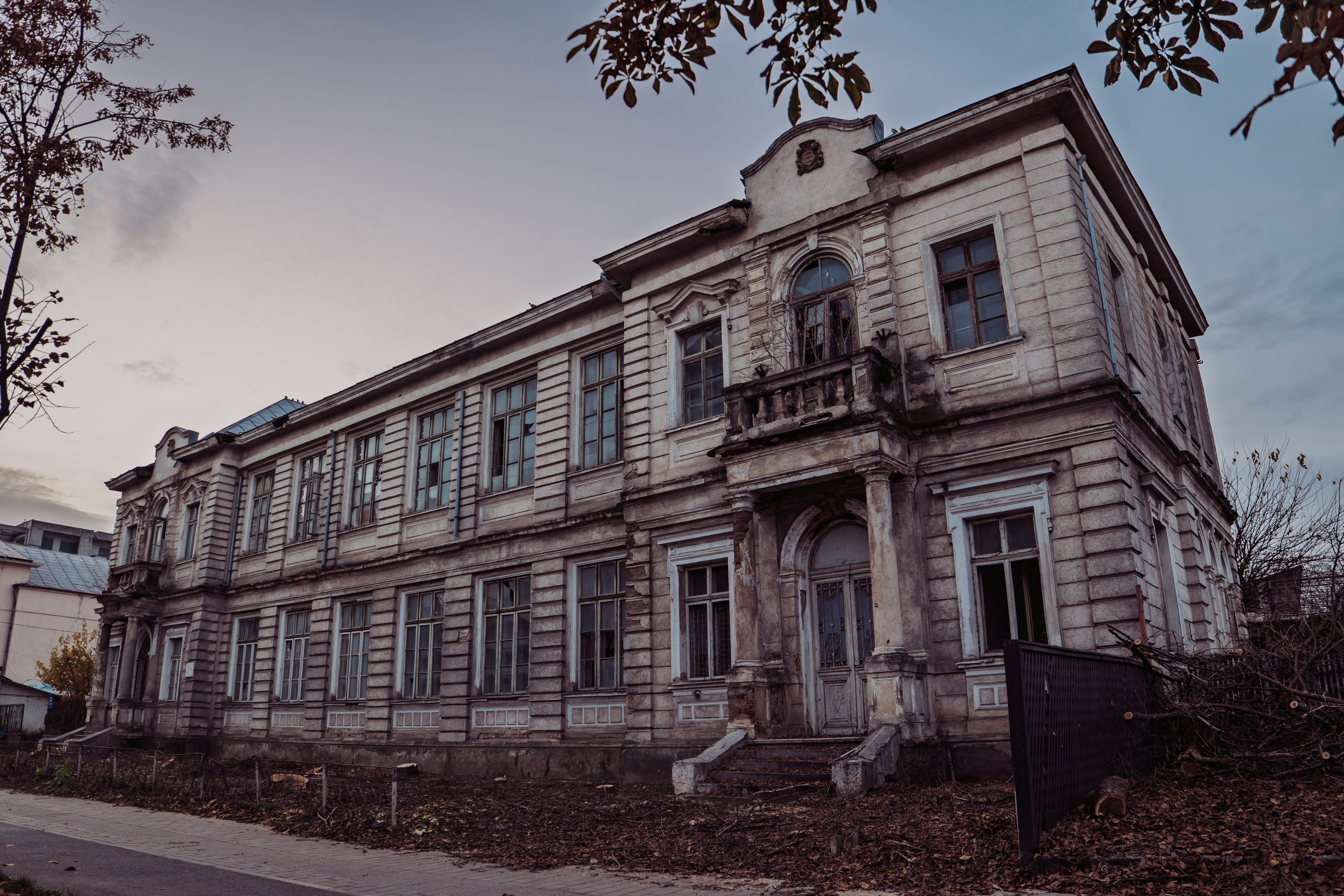 Haunted Facade: The Weathered Mansion Stands Sentinels of Time