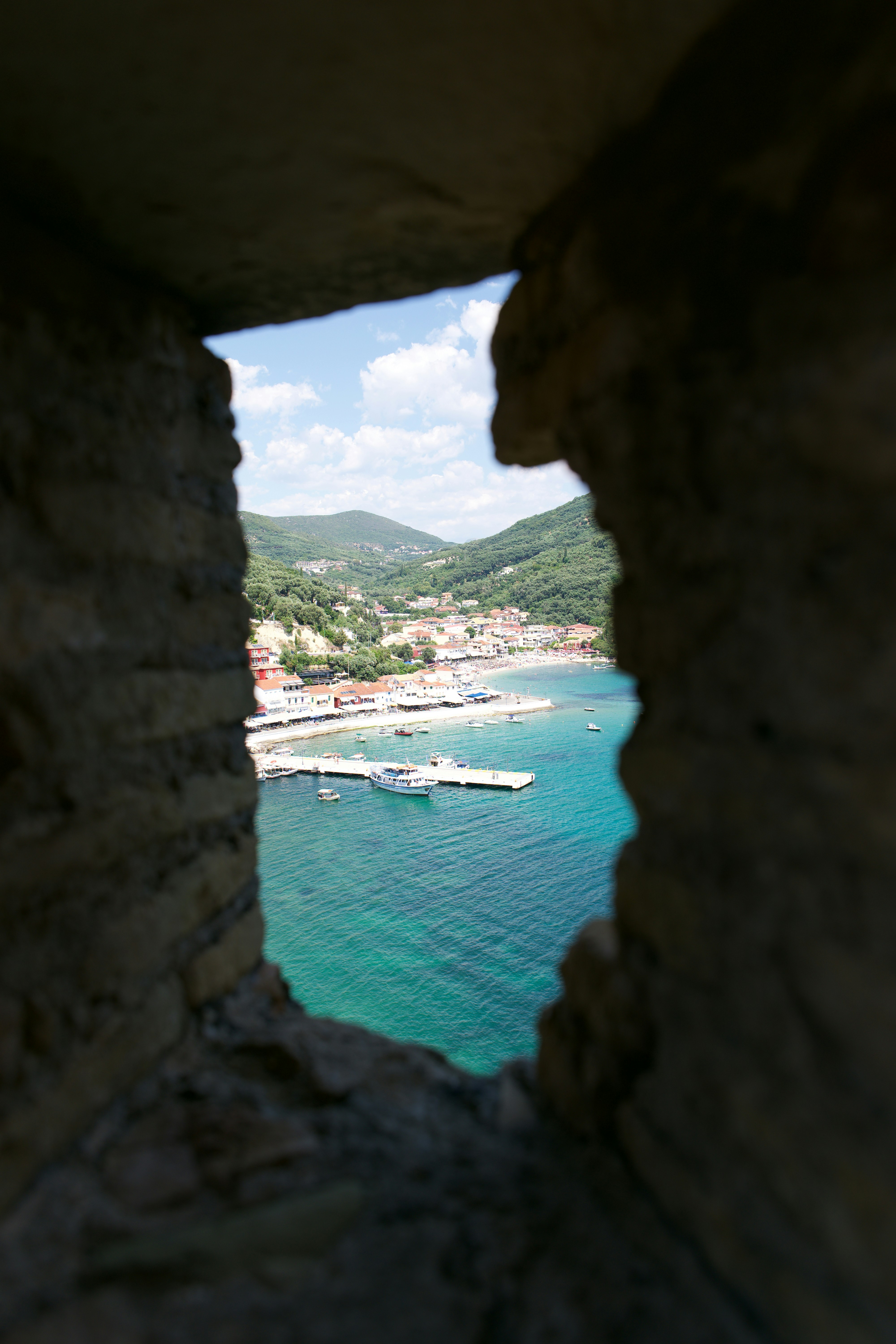 Citadel View: Coastal Village Framed by Ruined Arch