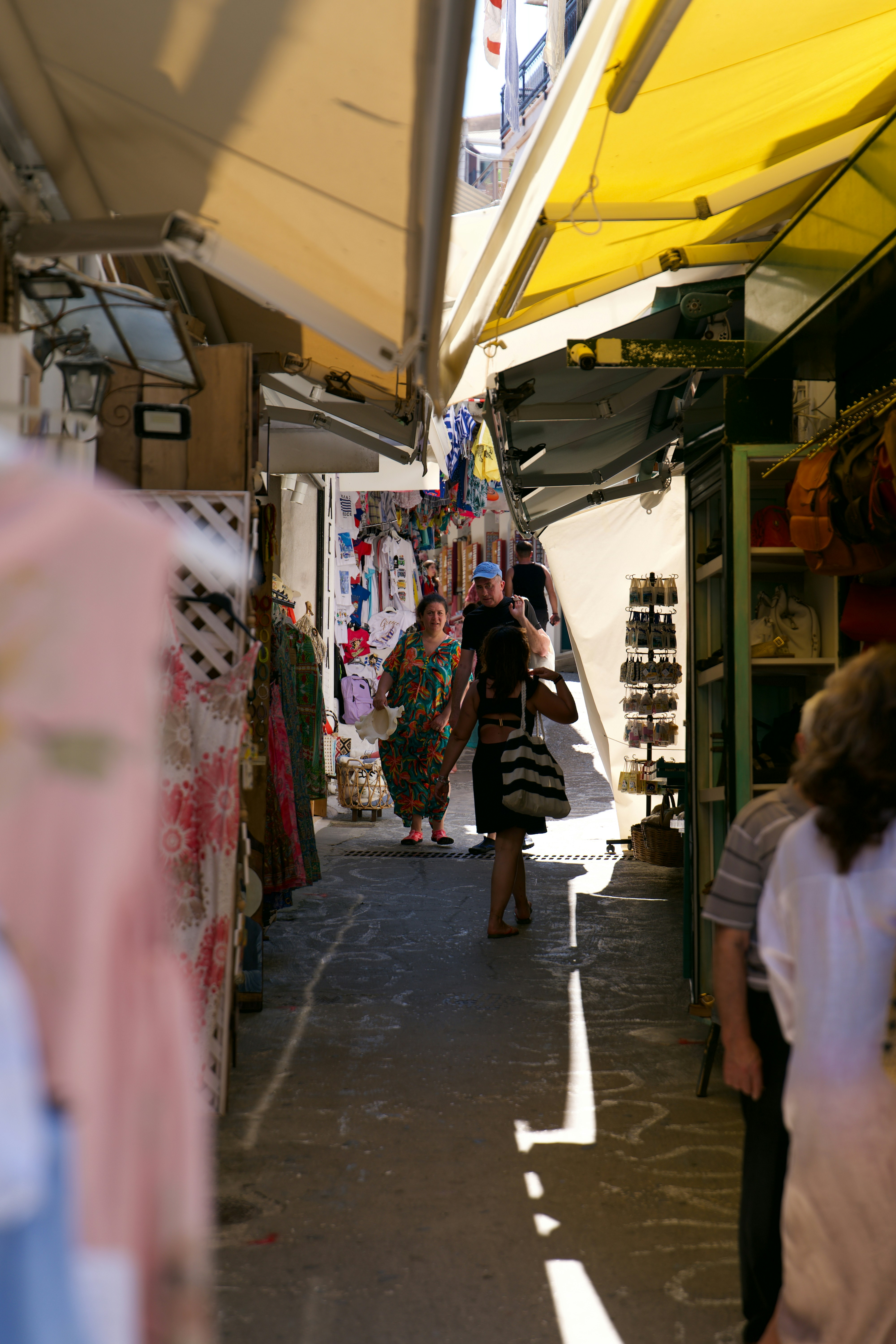 Sunlit Passage Through a Busy Market Lane