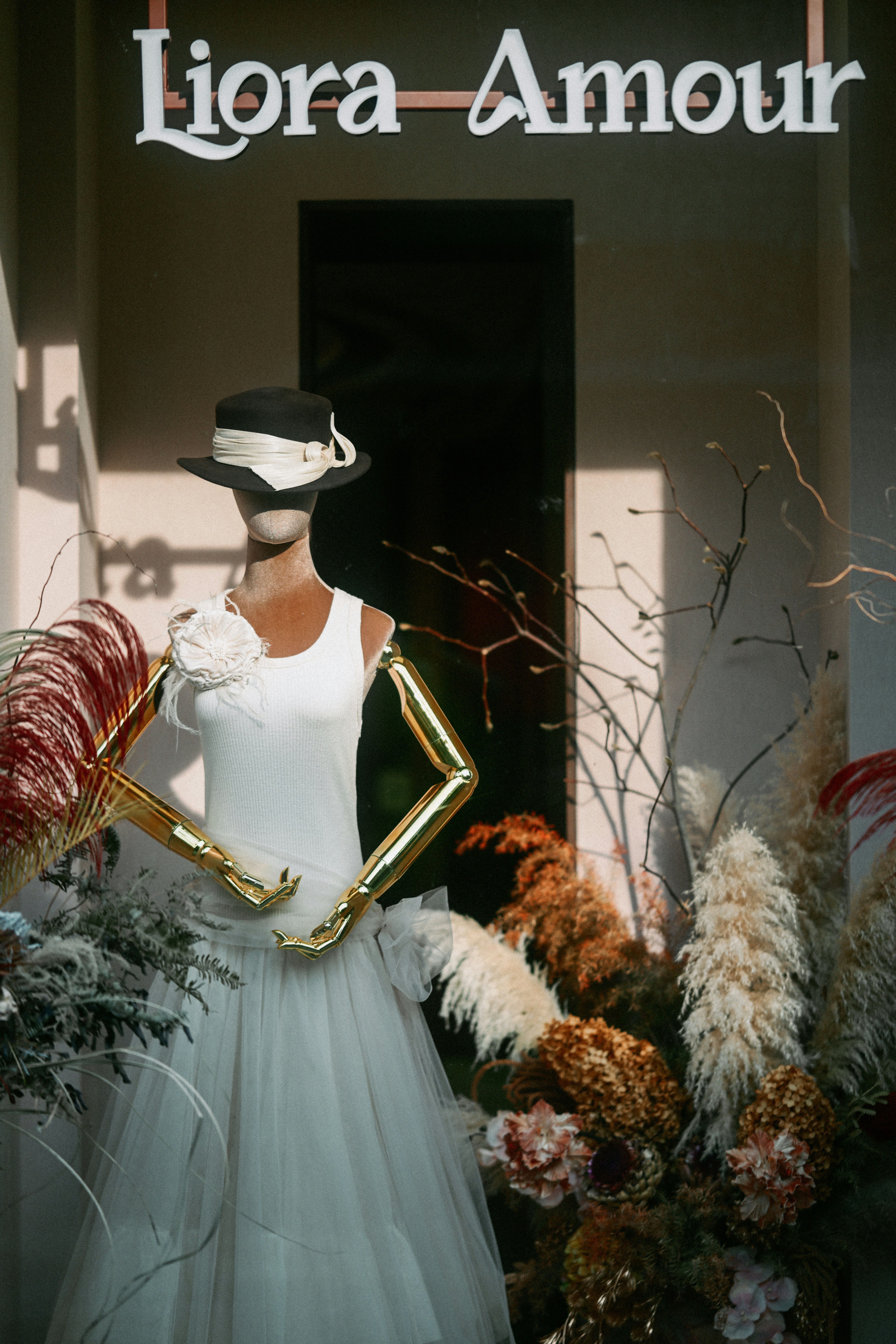 Silent Bride in Bloom: A mannequin in a white gown beneath Liora Amour