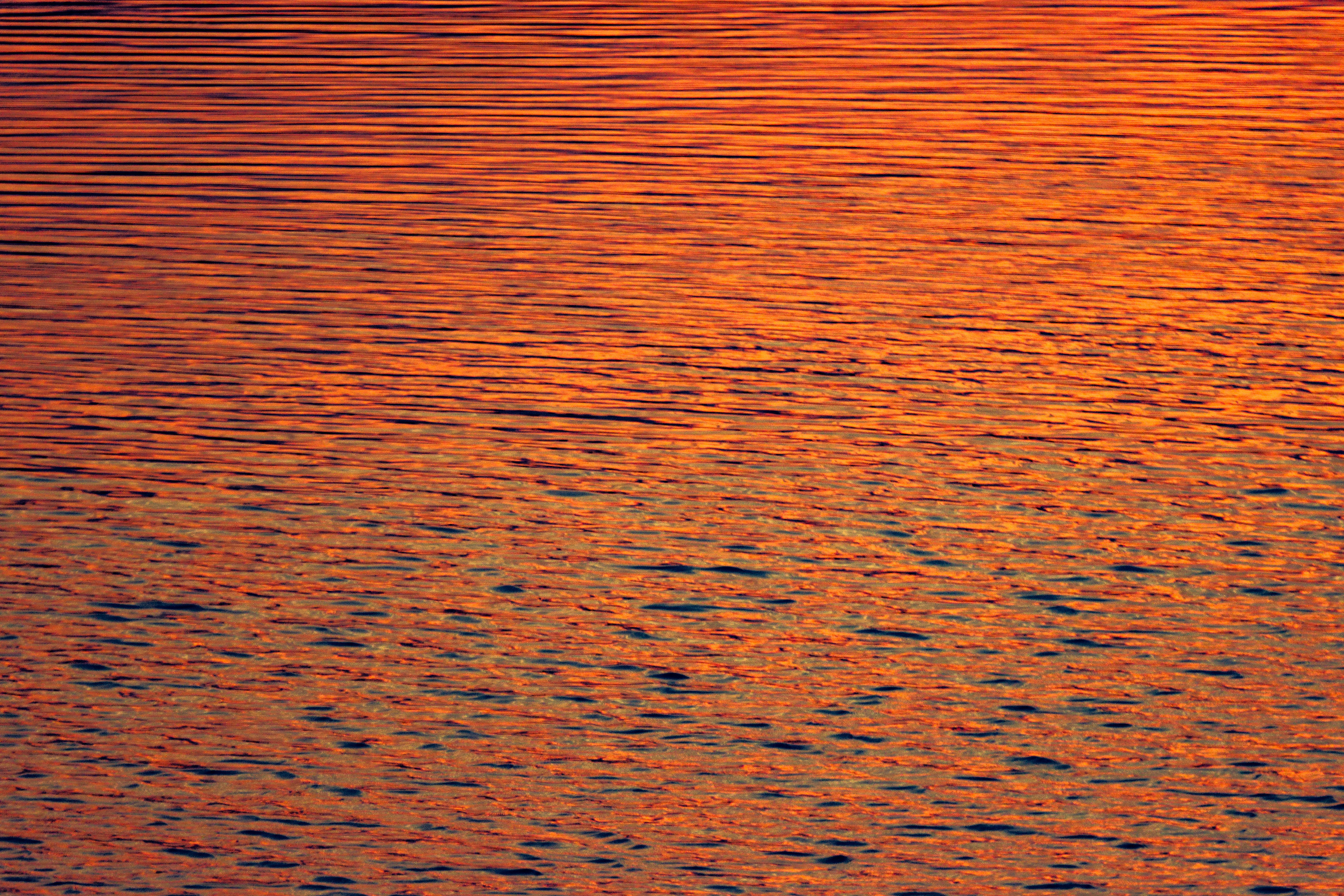 Sunset Ripplescape: Orange Glass Over a Quiet Sea