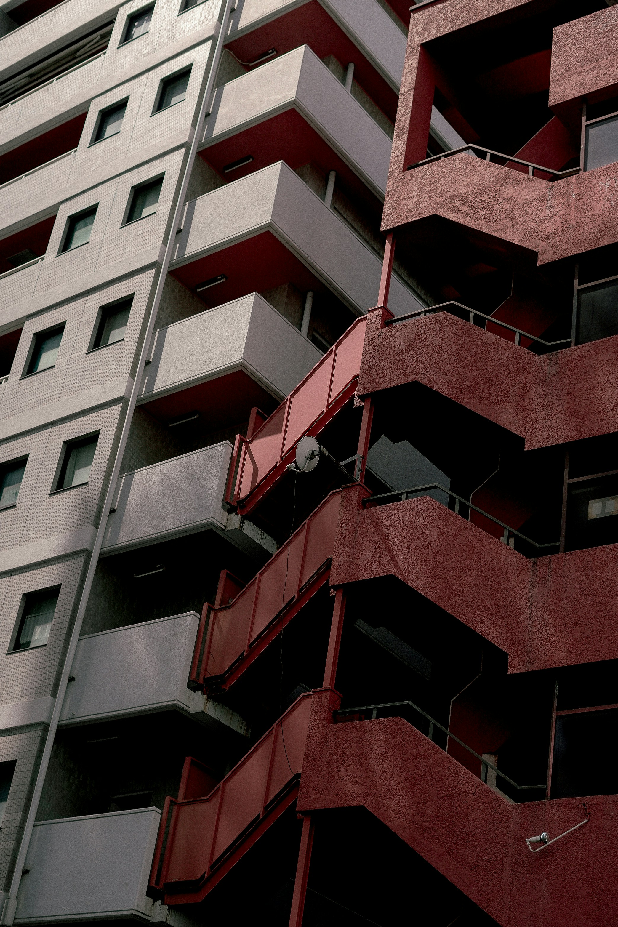 Stairways of Steel: Red and Gray Facades Converge in Urban Geometry