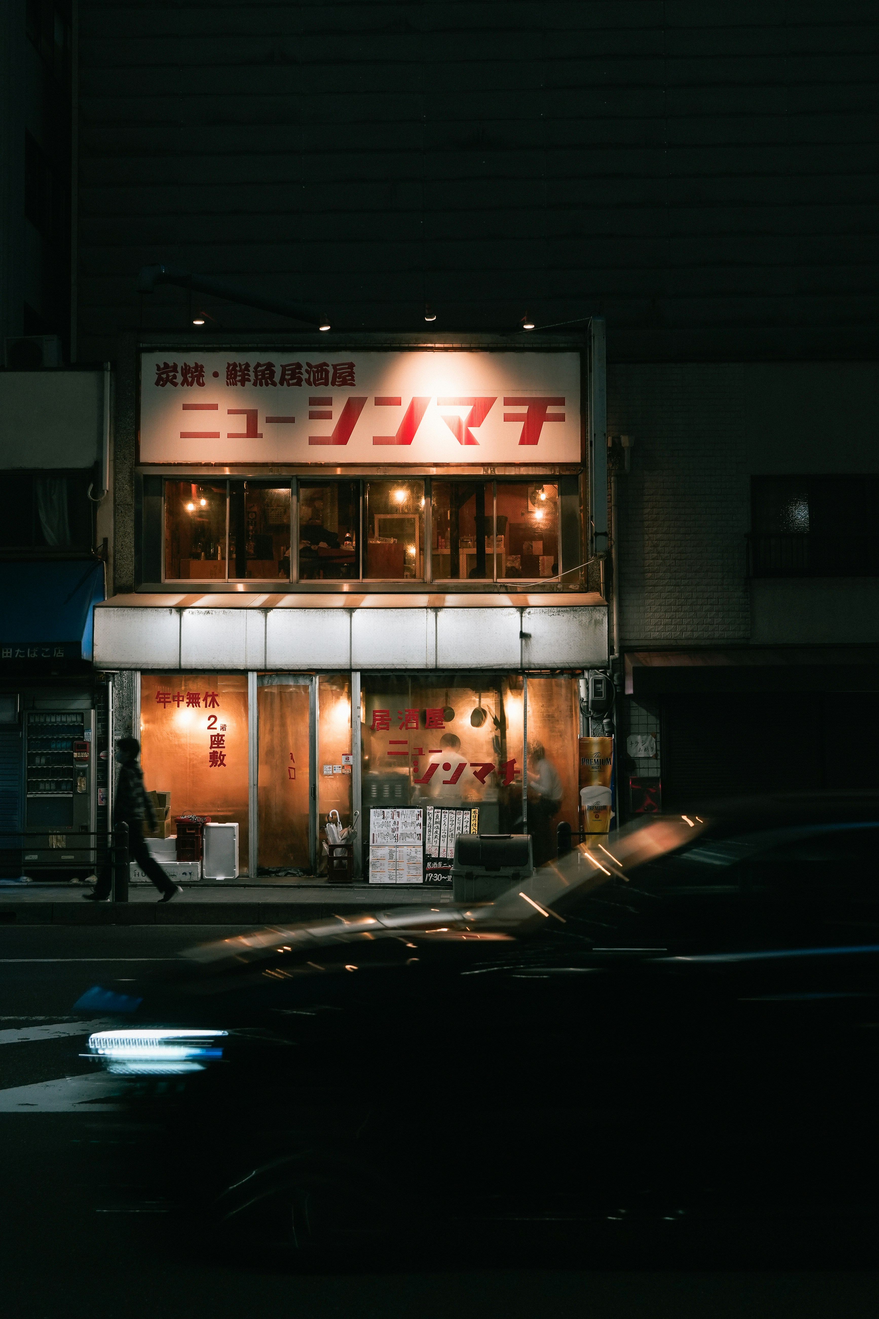 Neon Signage, Quiet Street, Night Haunting the Facade