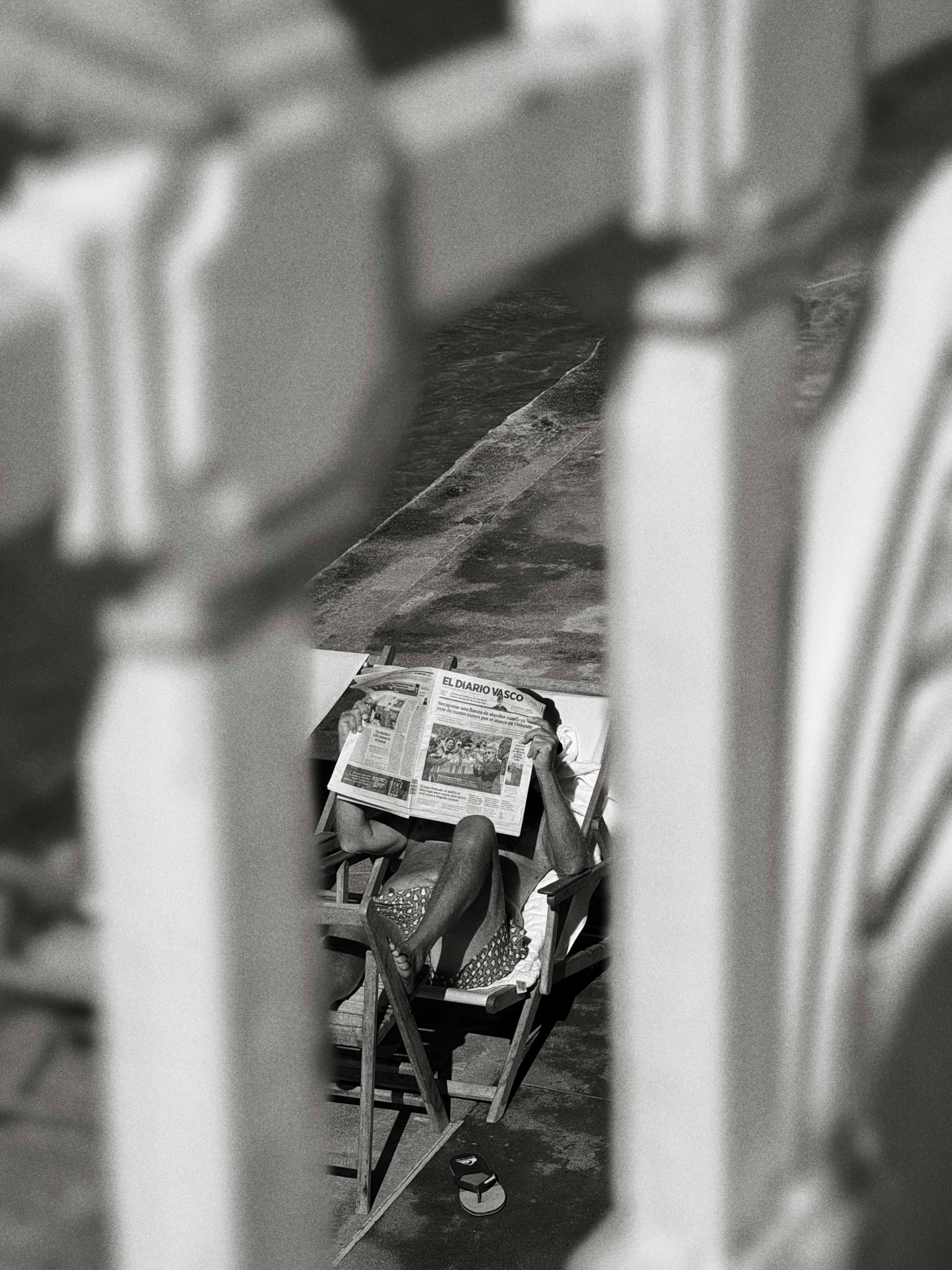 Overlooked Terrace: A Quiet Pause Between Chairs and Newsprint