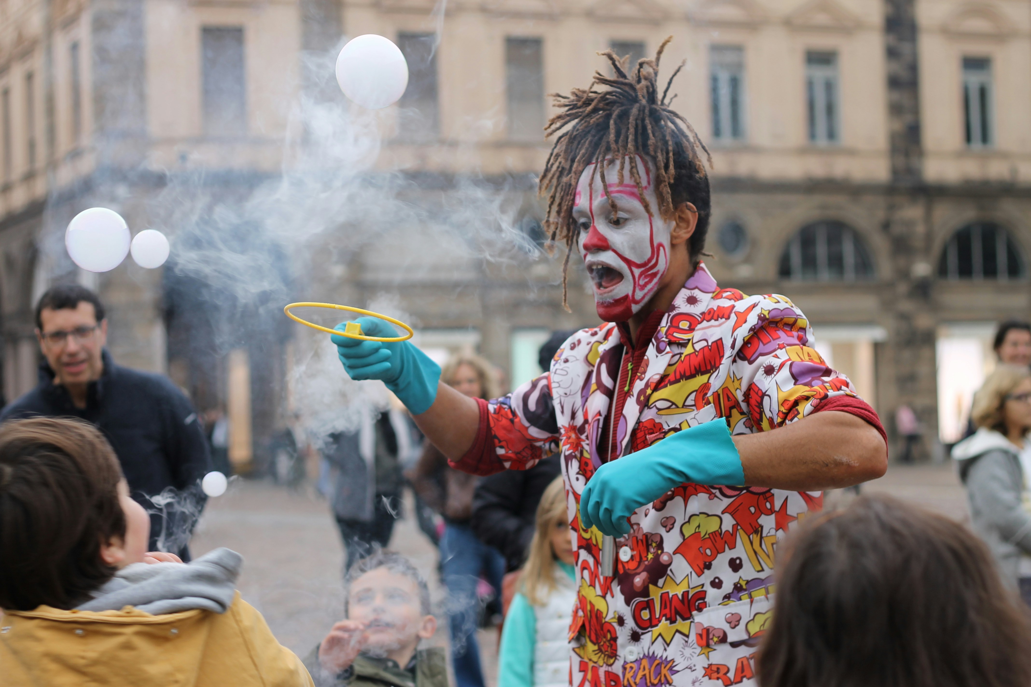 Clown in Color: A Street Performance Halting a Curious Crowd