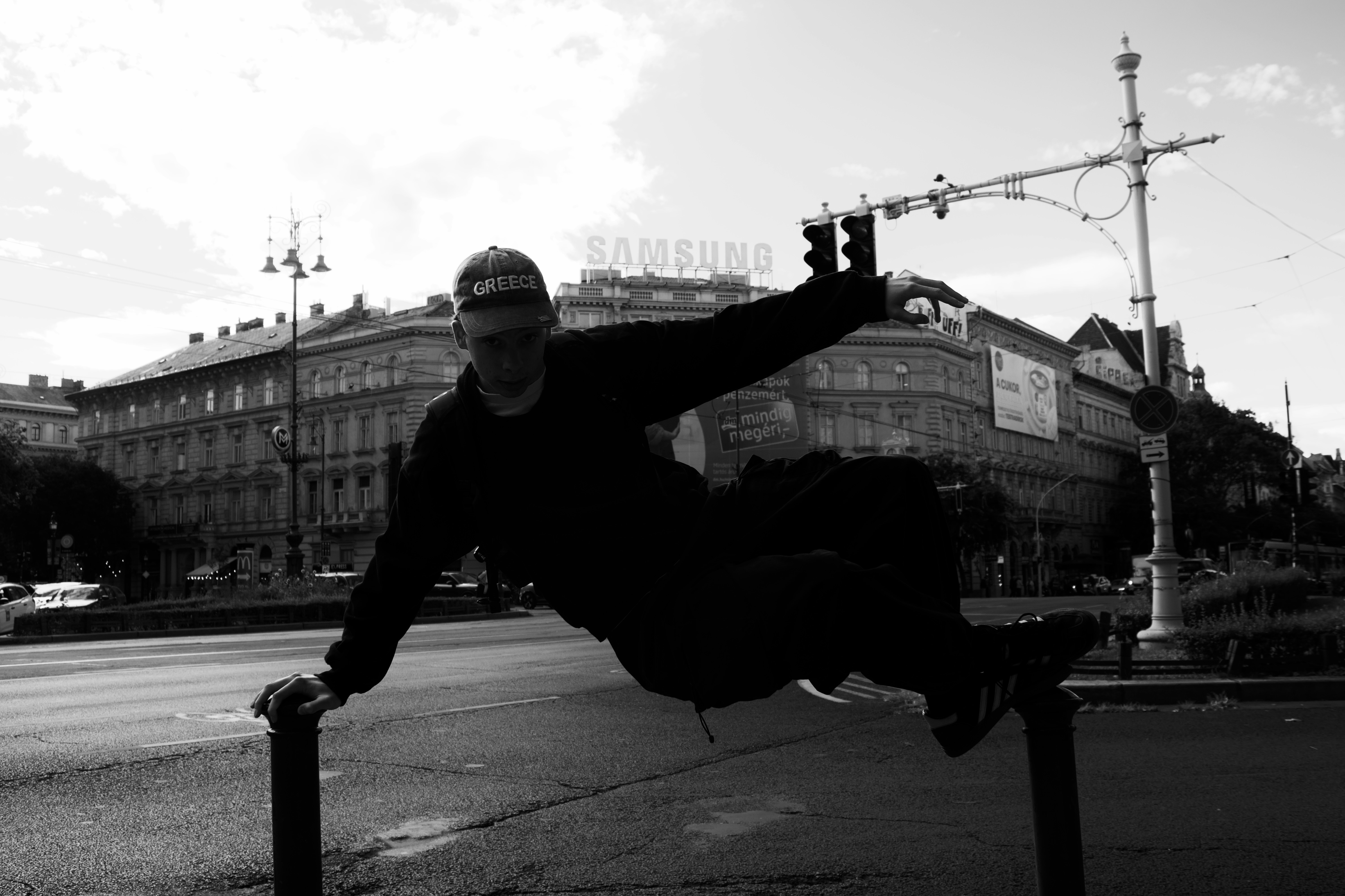 Urban Acrobat on a Rail: A Nighttime Street Performance in Black and White