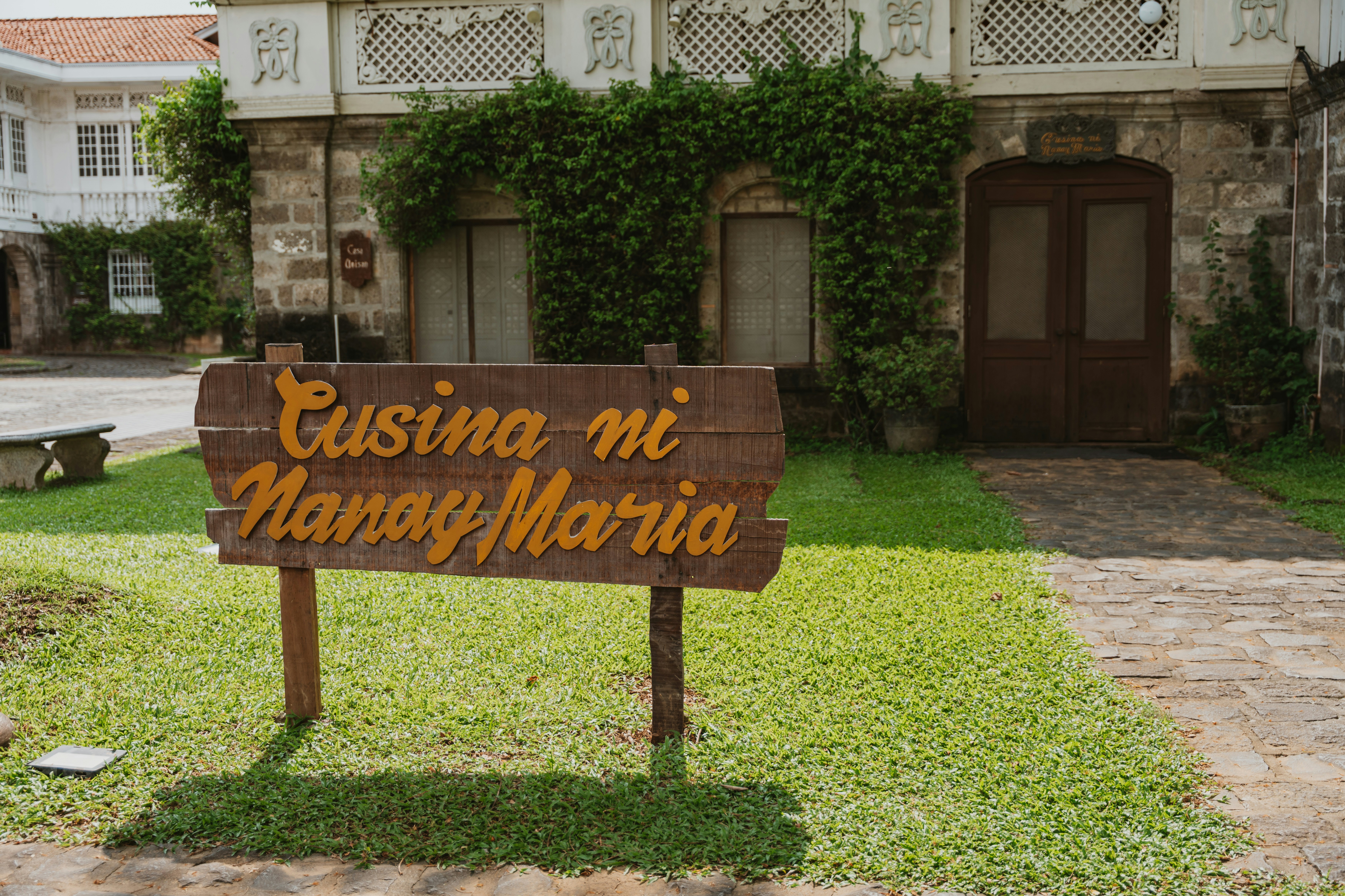 Wooden Sign for a Tuscan-Style Courtyard Fronting a Stone Estate