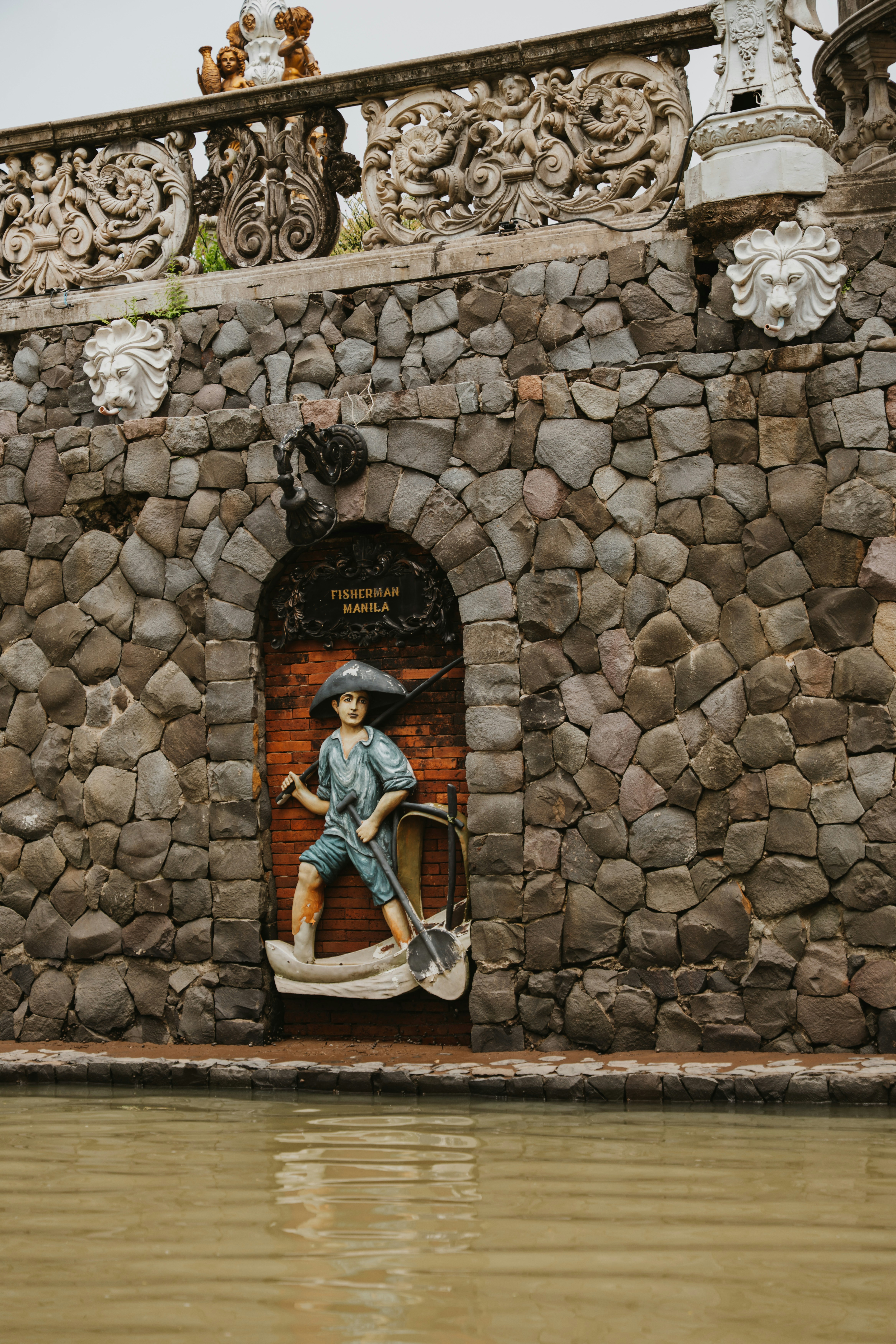 Statue in the Walled Alcove: Fisherman Manila