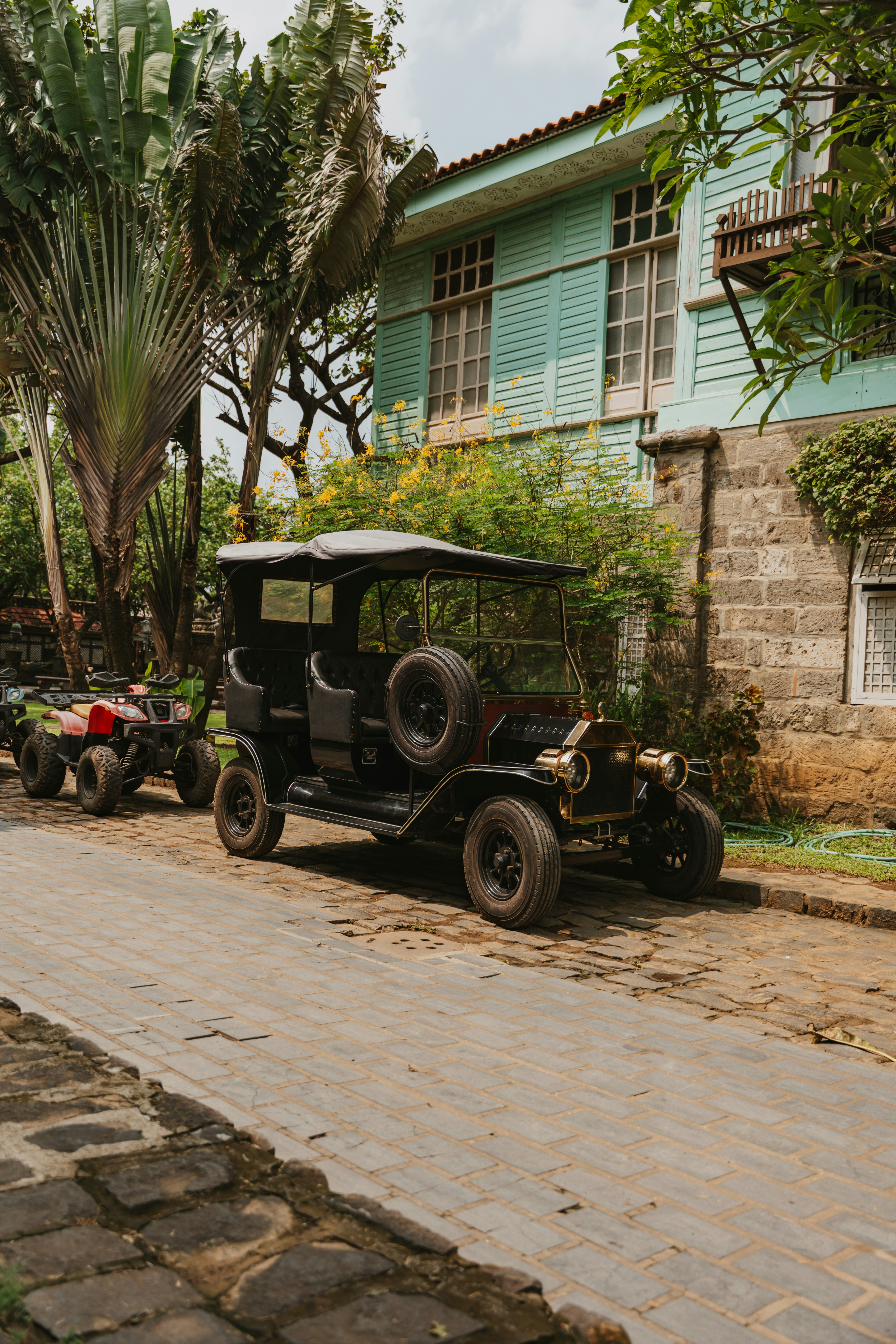 Nocturne of the Pedestrian Lane: A Vintage Car Resting by a Turquoise House