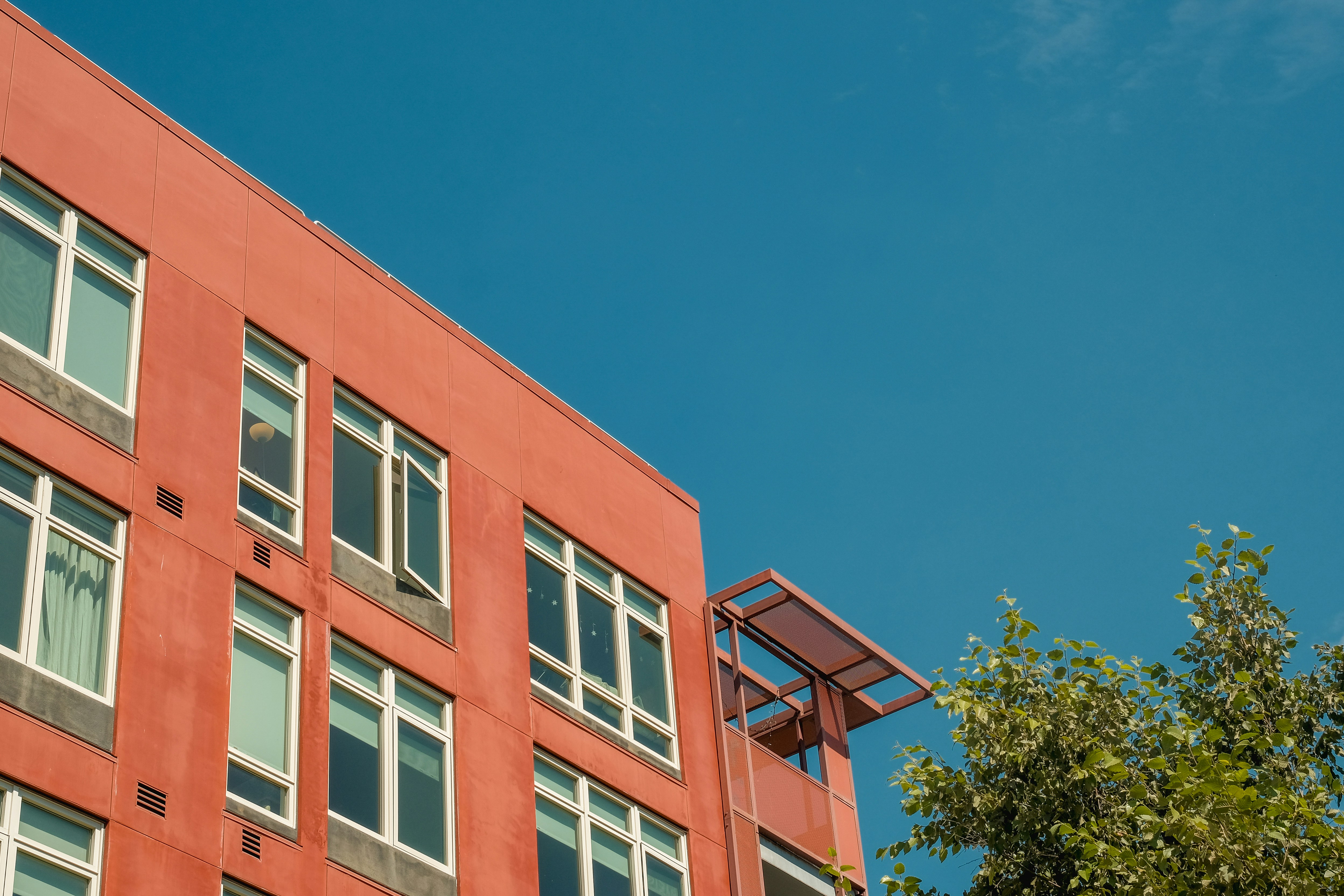 Red Brick Facade Reaching Toward a Clear Sky