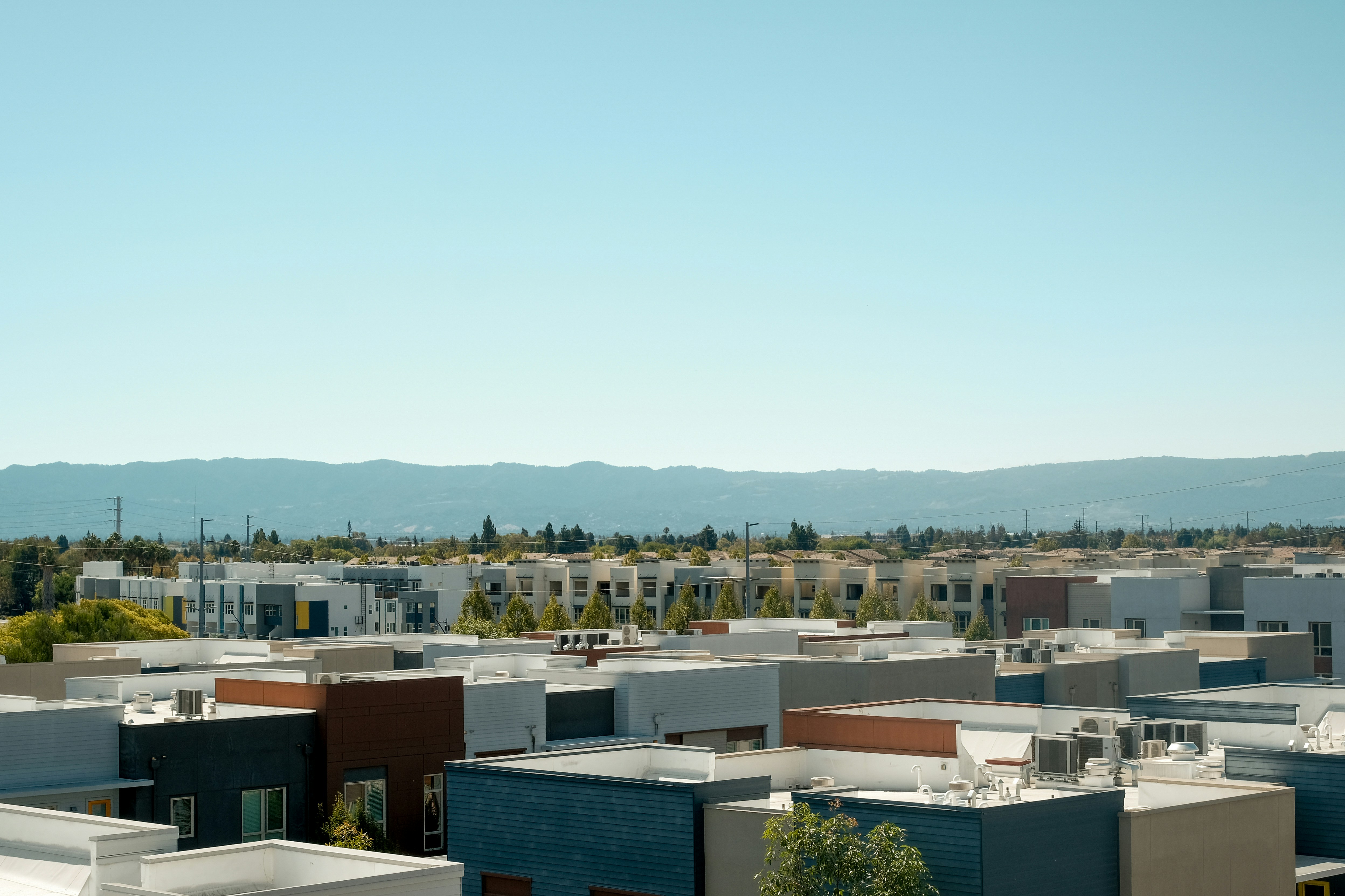 Urban Horizon: A Quiet Terrace of Modern Apartment Blocks Under a Clear Sky