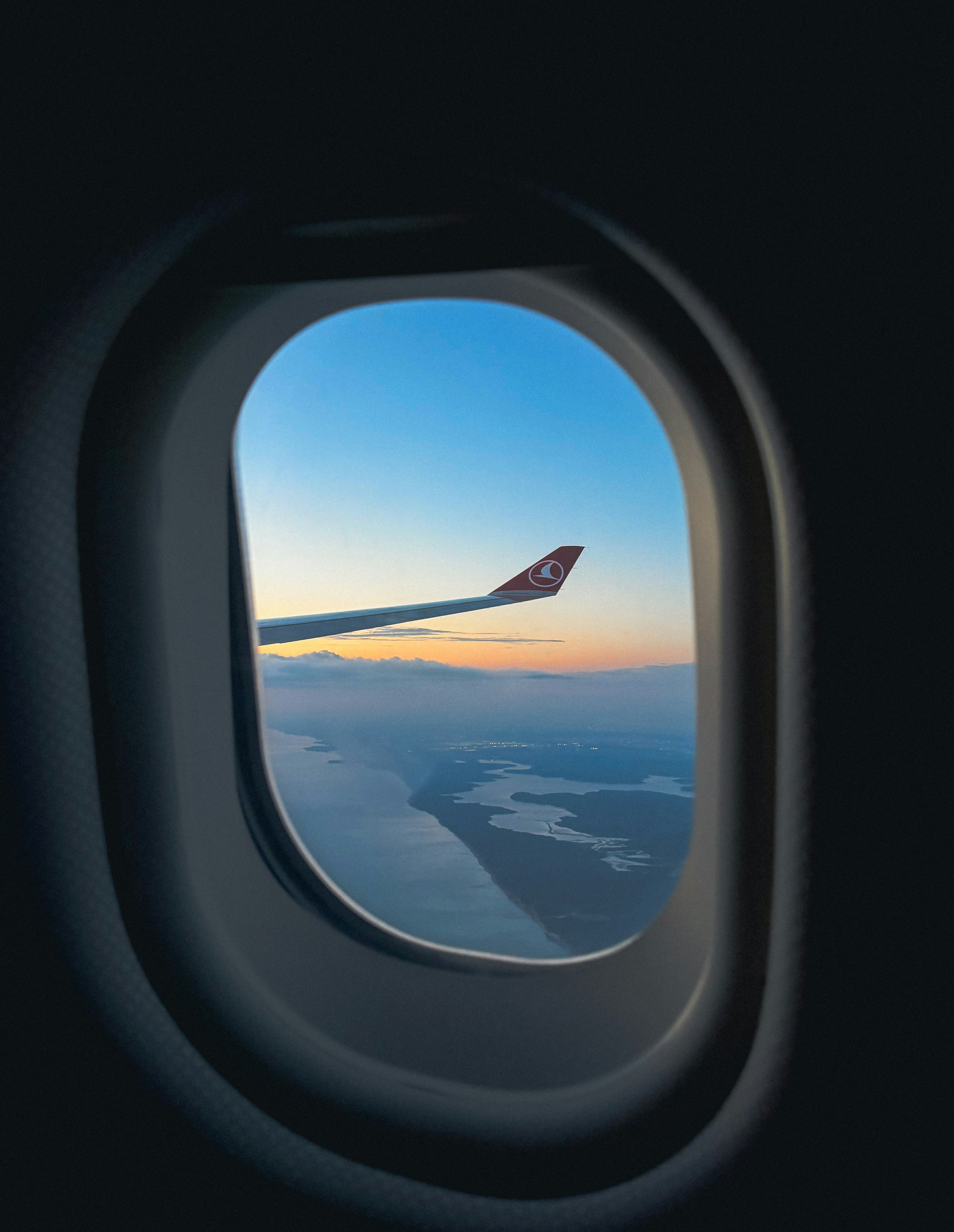 Window View: Sunset Over Clouds and Wingtip