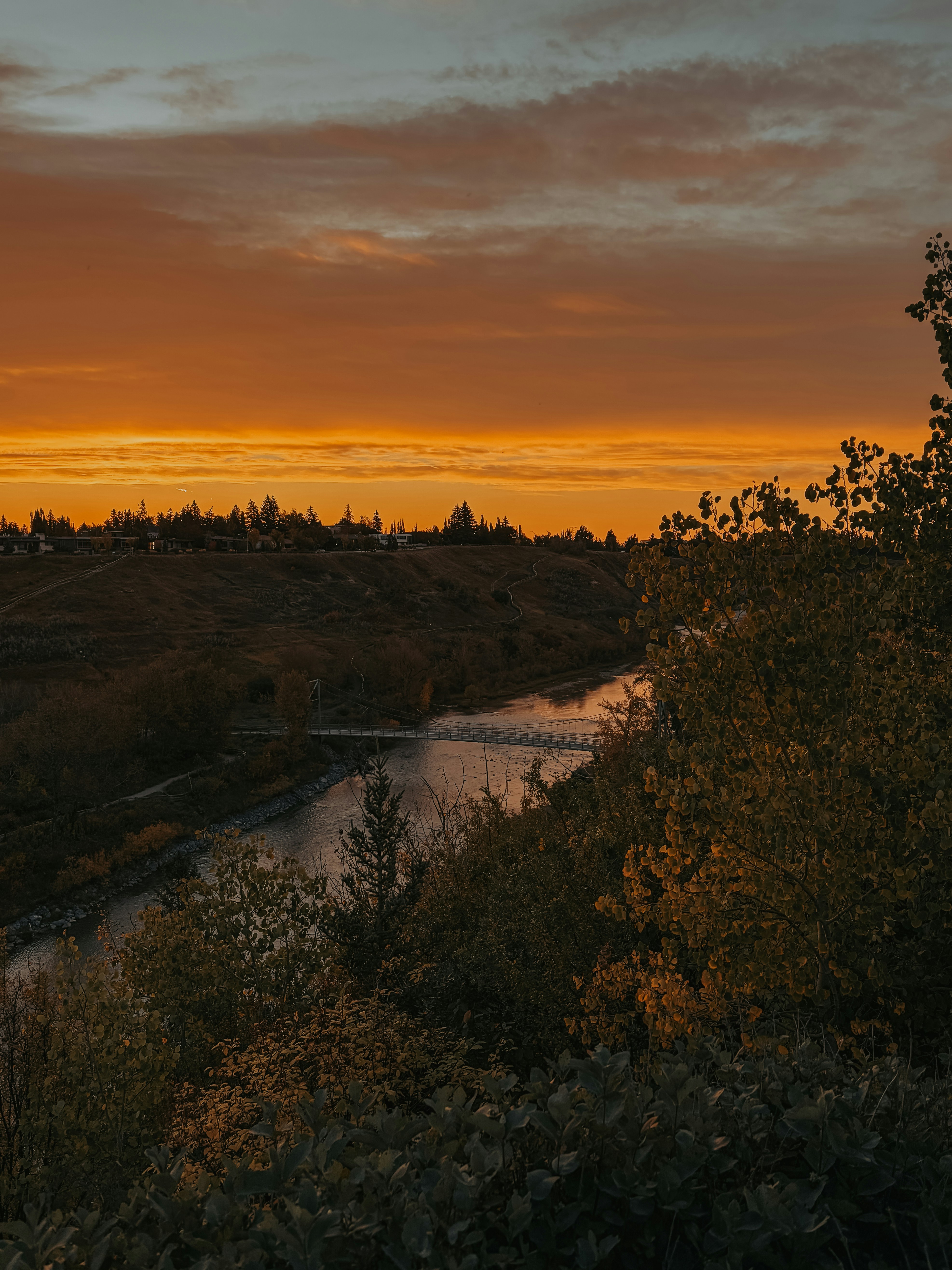 Golden River Vista at Dusk: A River Winding Through Autumn Hills