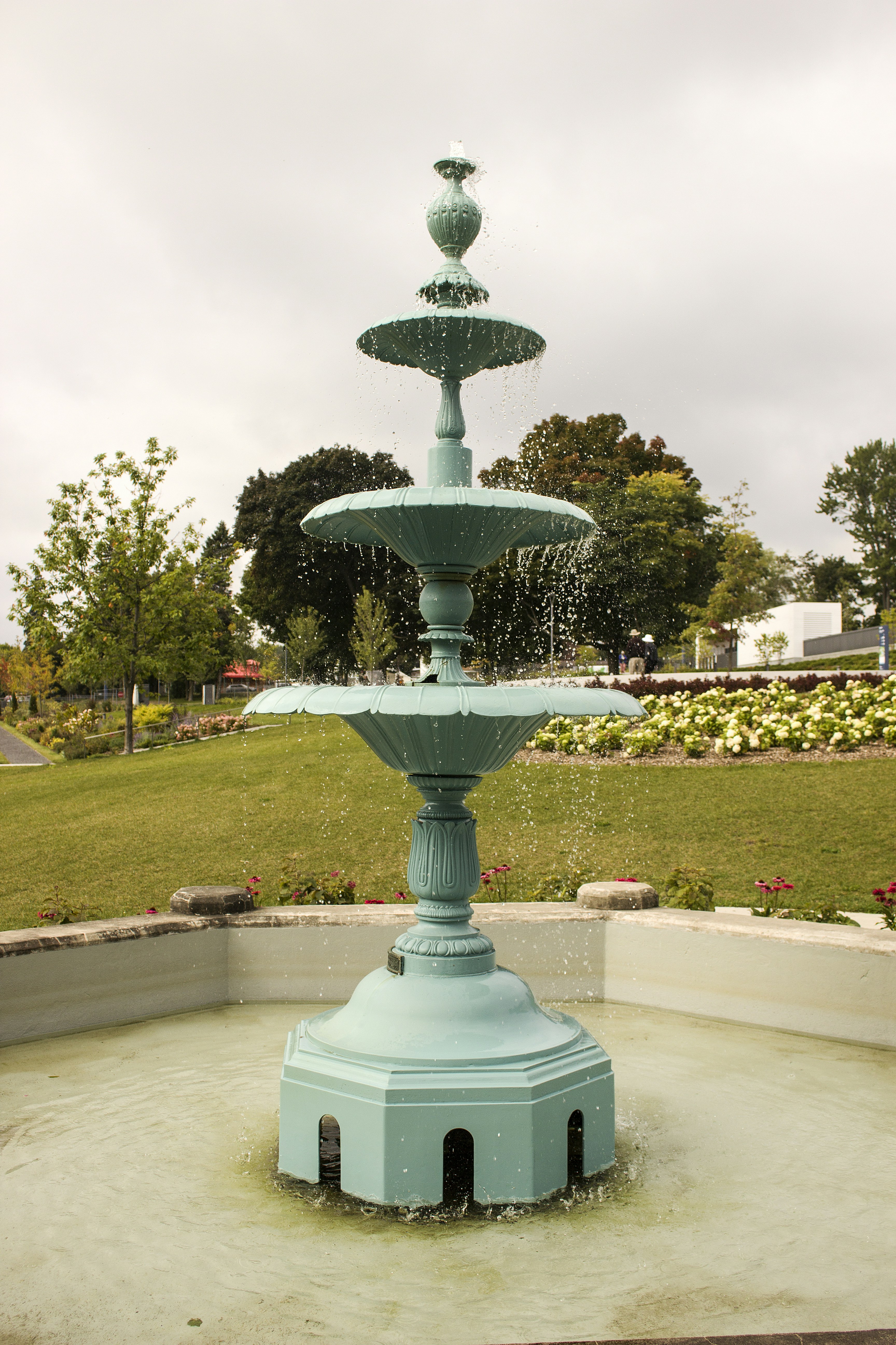 Verdant Three-Tiered Fountain Standalone in a Parked Sunlight