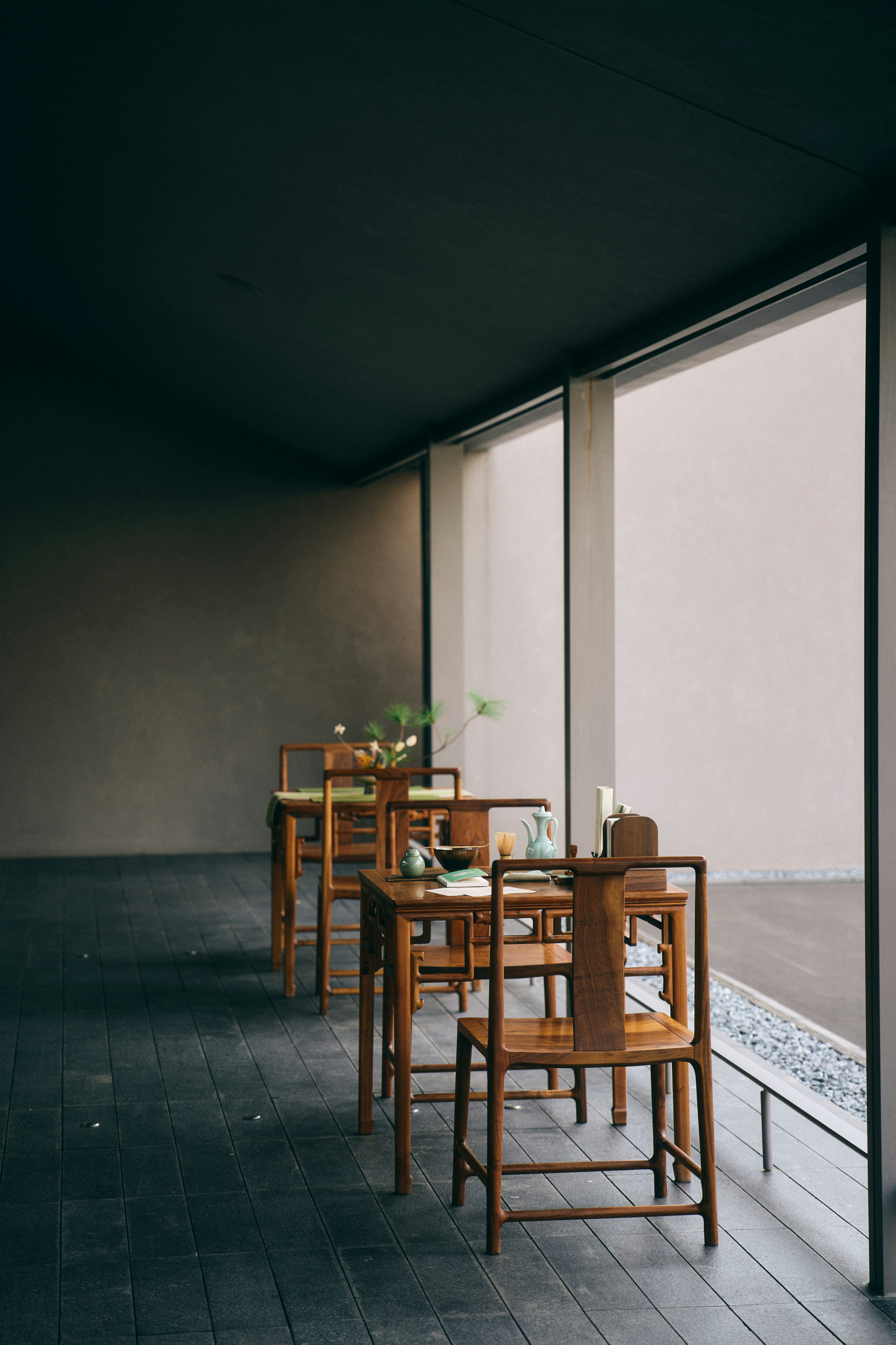 Minimalist Still Life: Wooden Chairs by Glass Wall in Soft Light