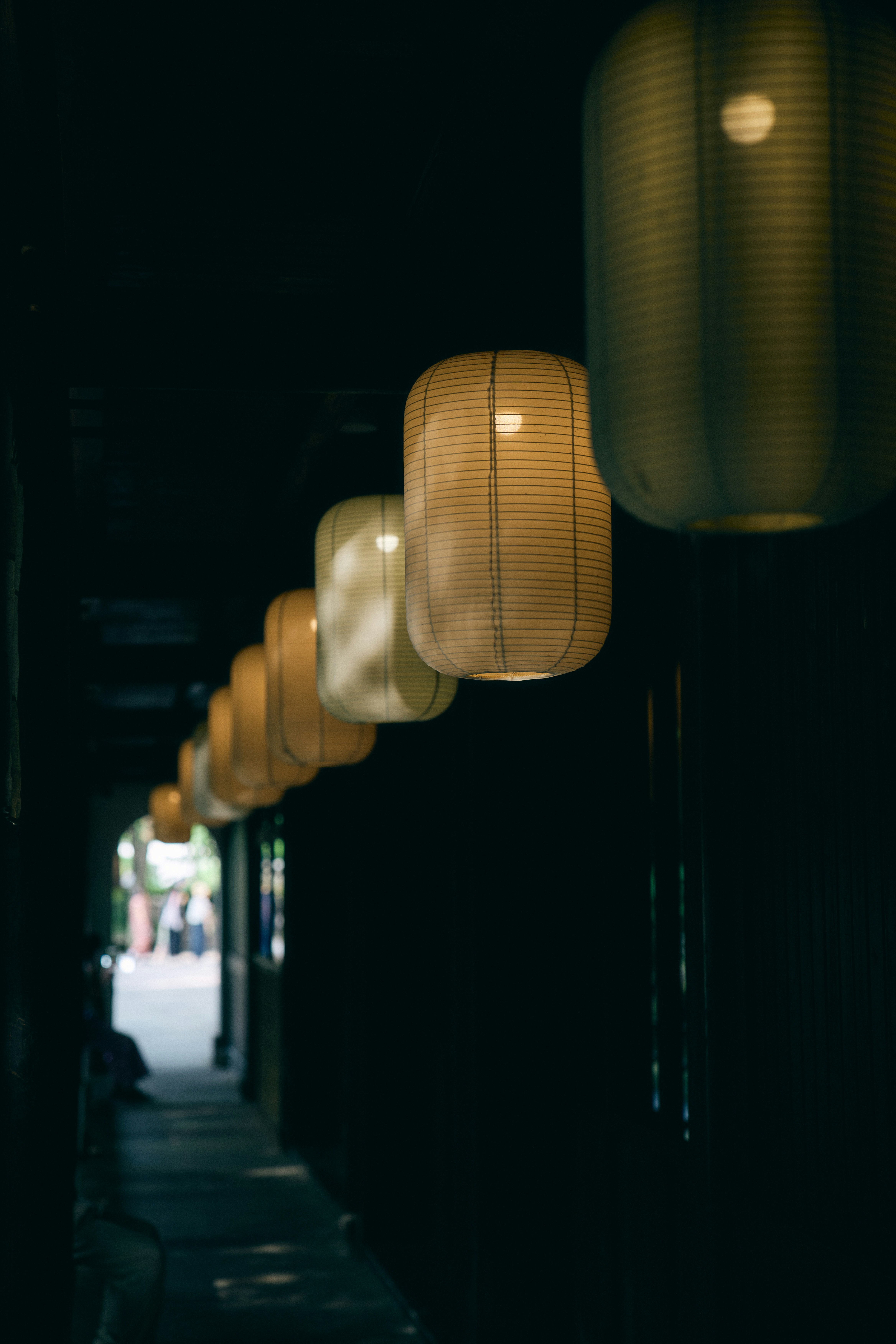 Soft lanterns in a shadowed alleyway