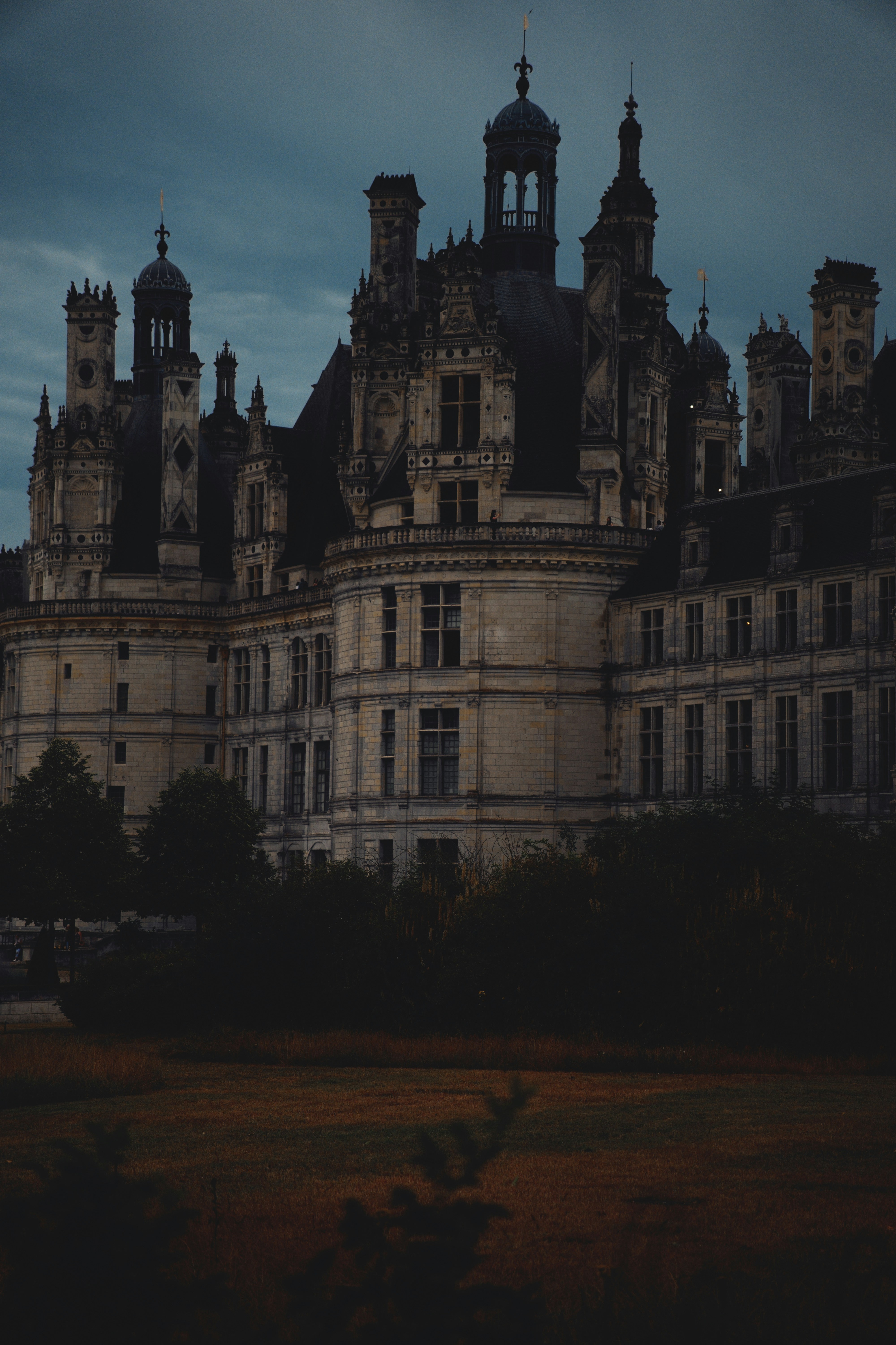 Gothic Facades at Dusk: A Schloss silhouette under a moody sky