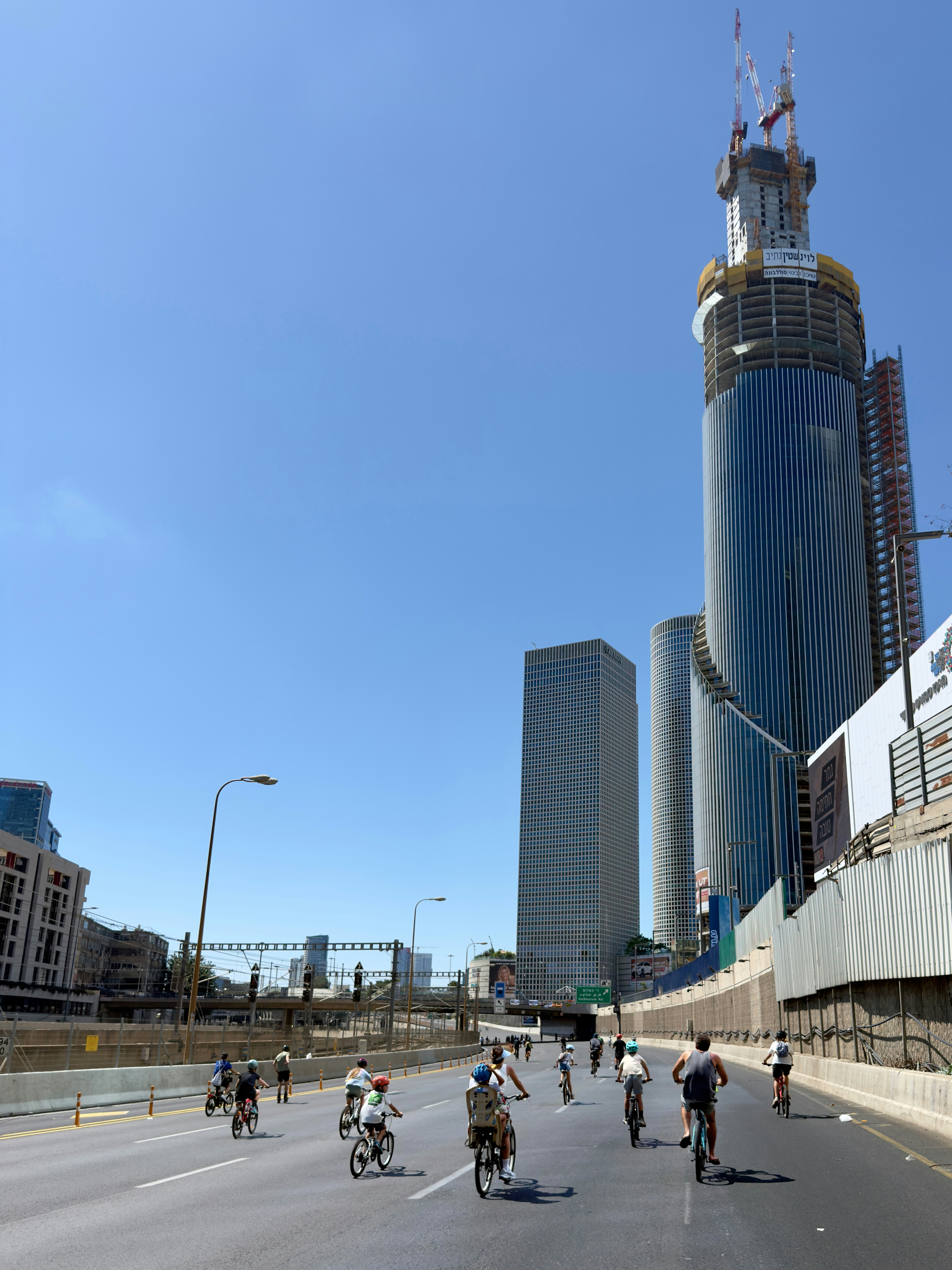 Tower Rise Over a Freeway of Cyclists