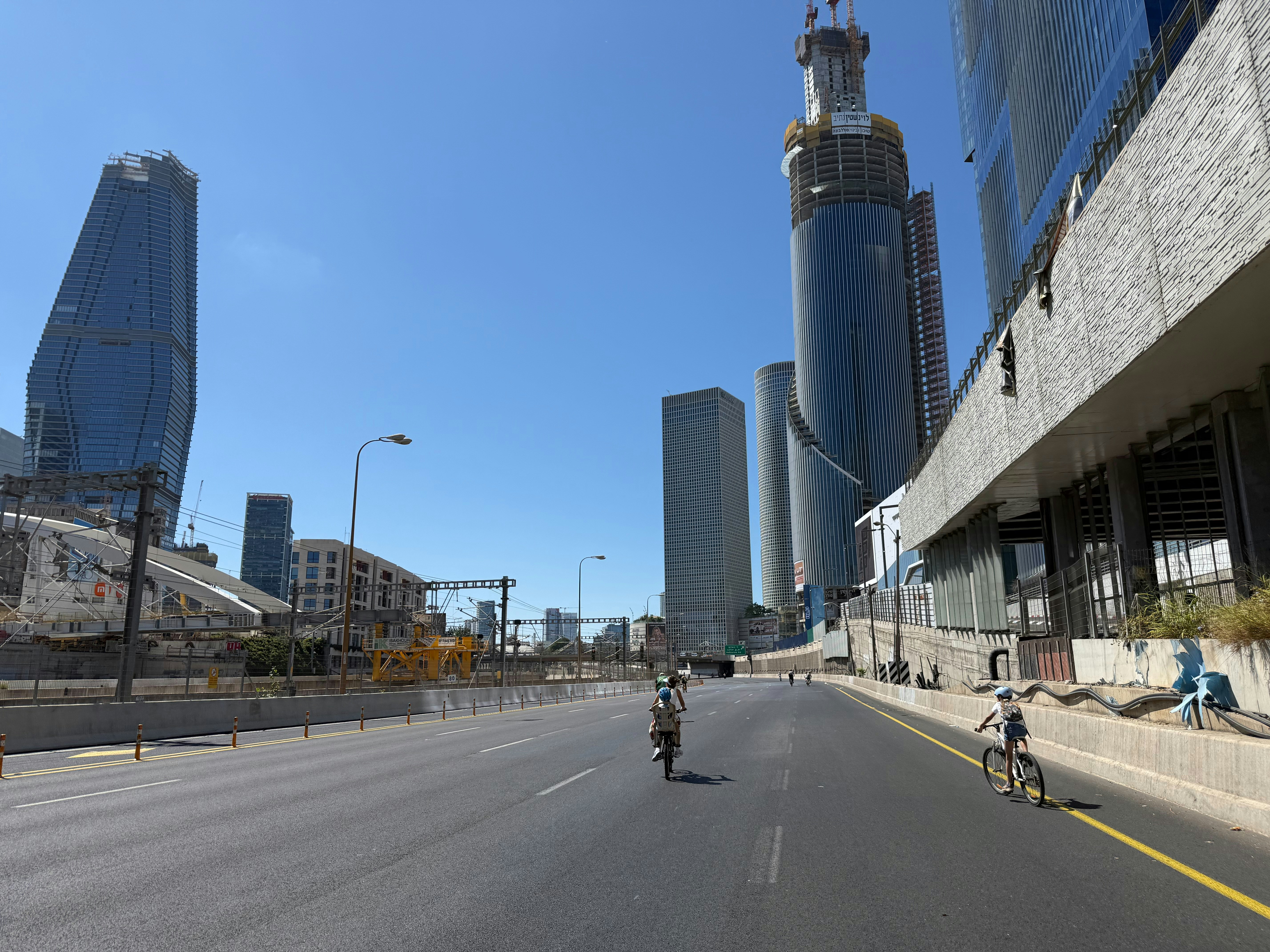 Center of Urban Motion: Riders and Skyscrapers on a Quiet Boulevard
