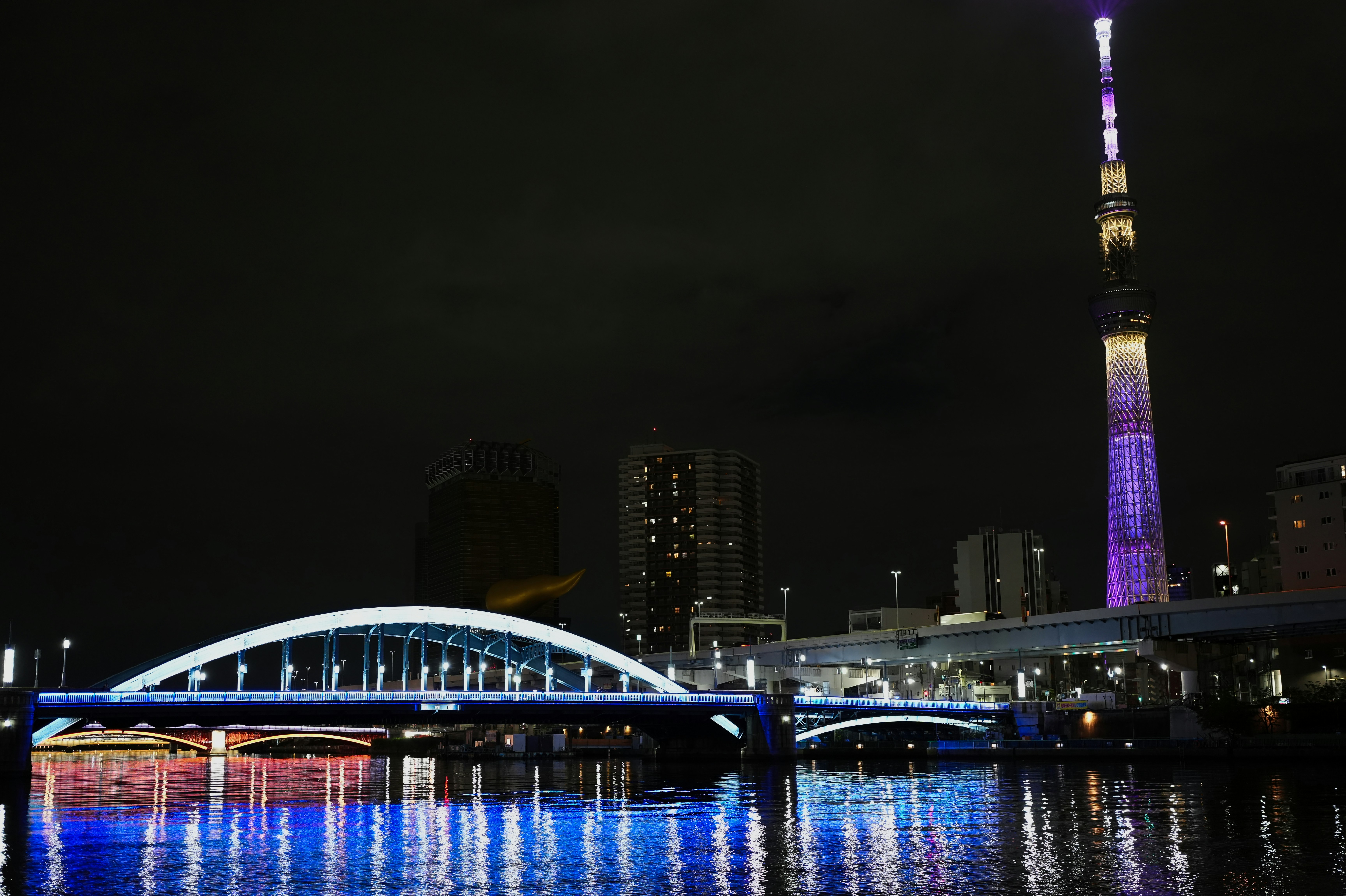 Neon River Nights: Tokyo Tower Glow Over a Quiet Bridge