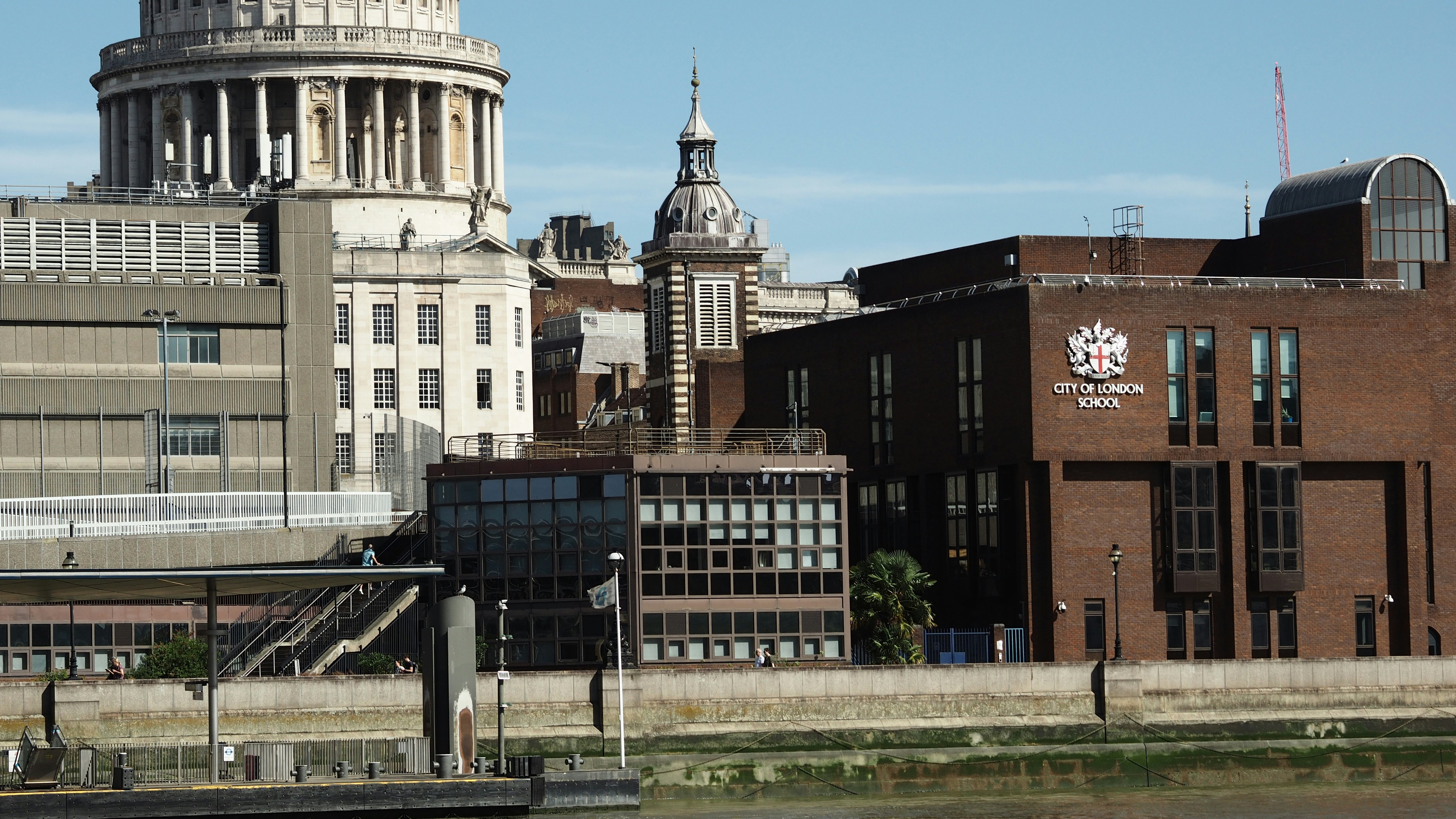Stately Riverside Complex Framing the City’s Historic and Modern Edges