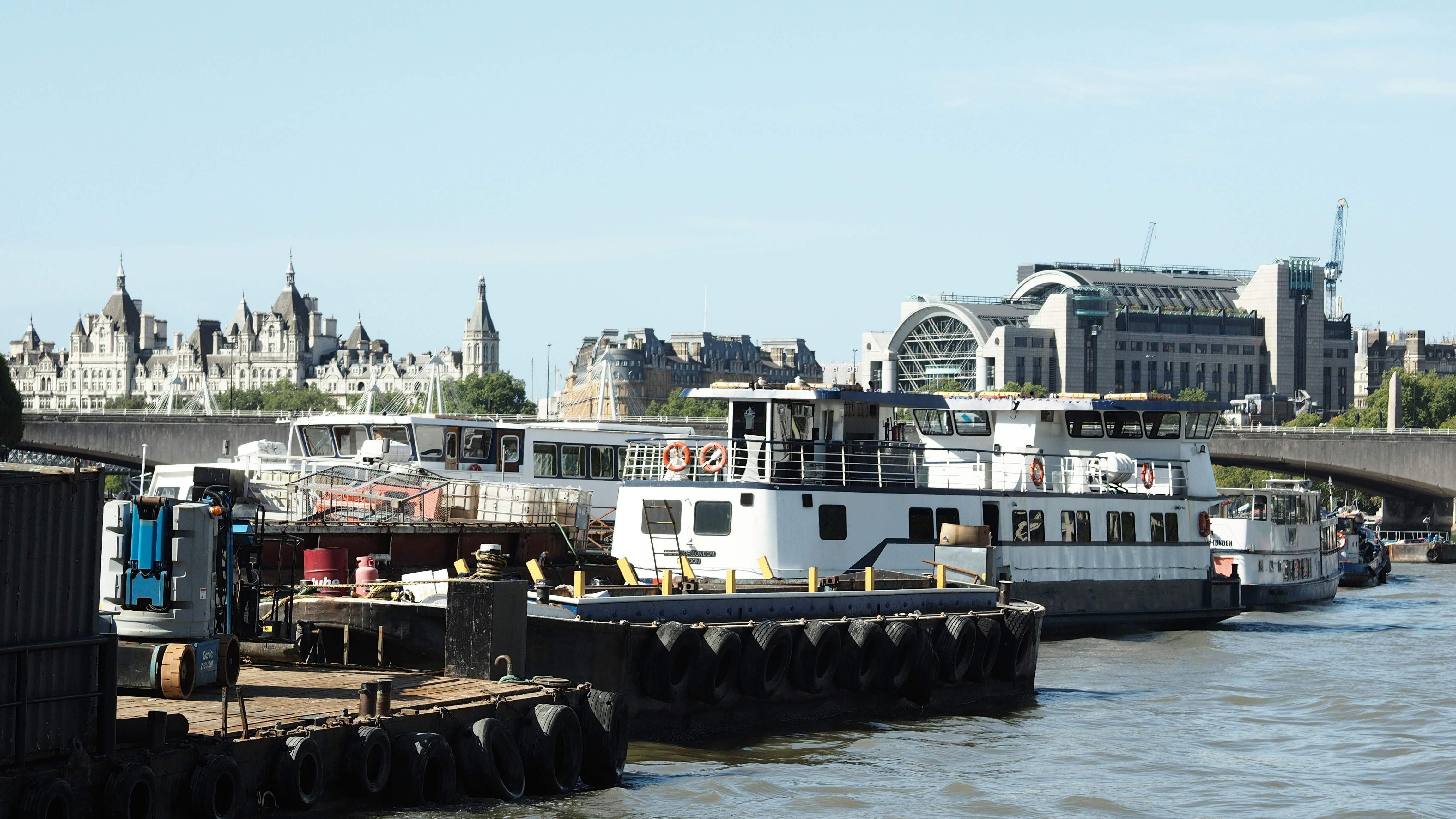 Dockside Parade: Boats, Water, and City Silhouette
