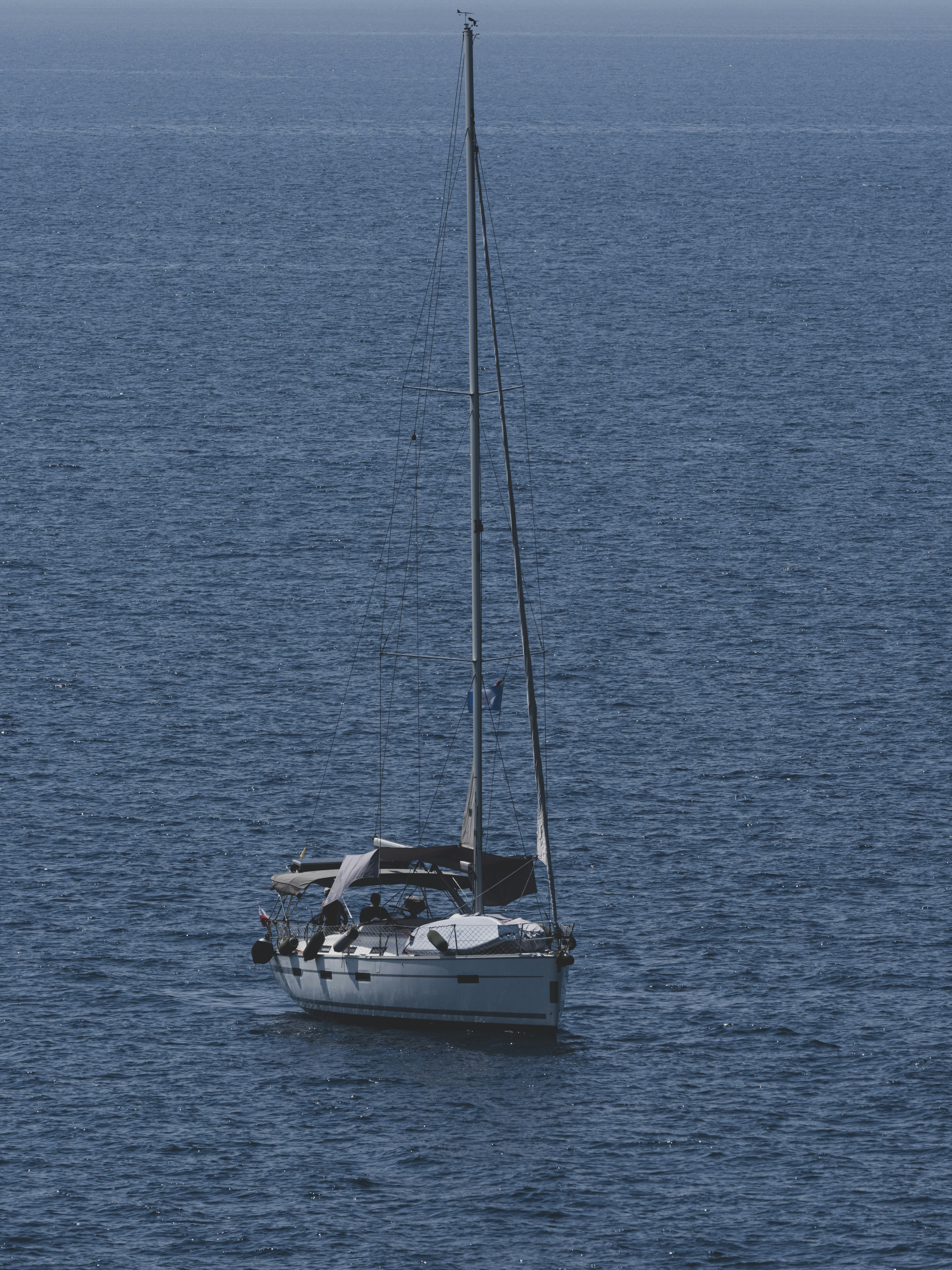 Sailboat Quietly Anchored in a Sea of Blue