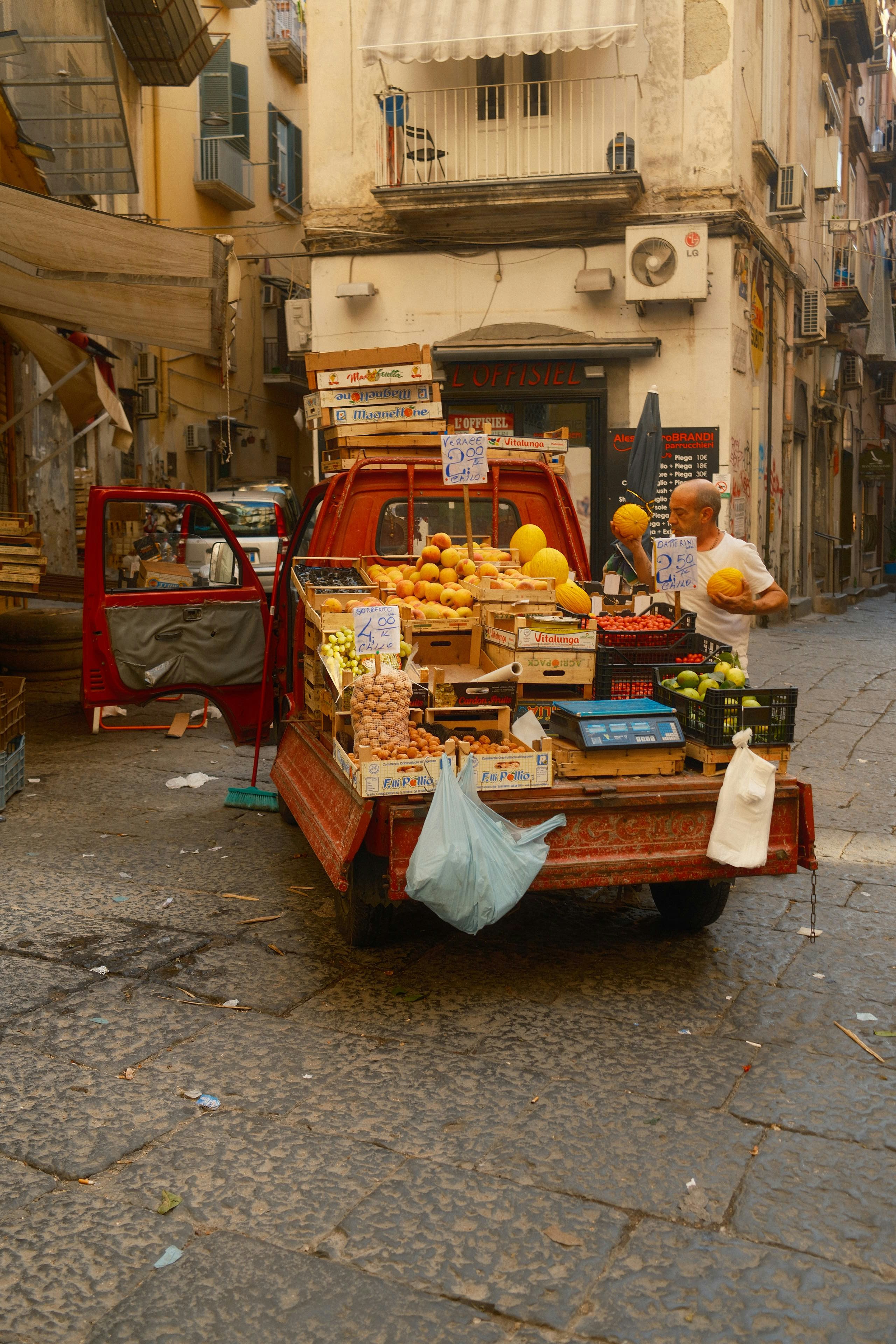 Fruit Stall in a Sunlit Narrow Street